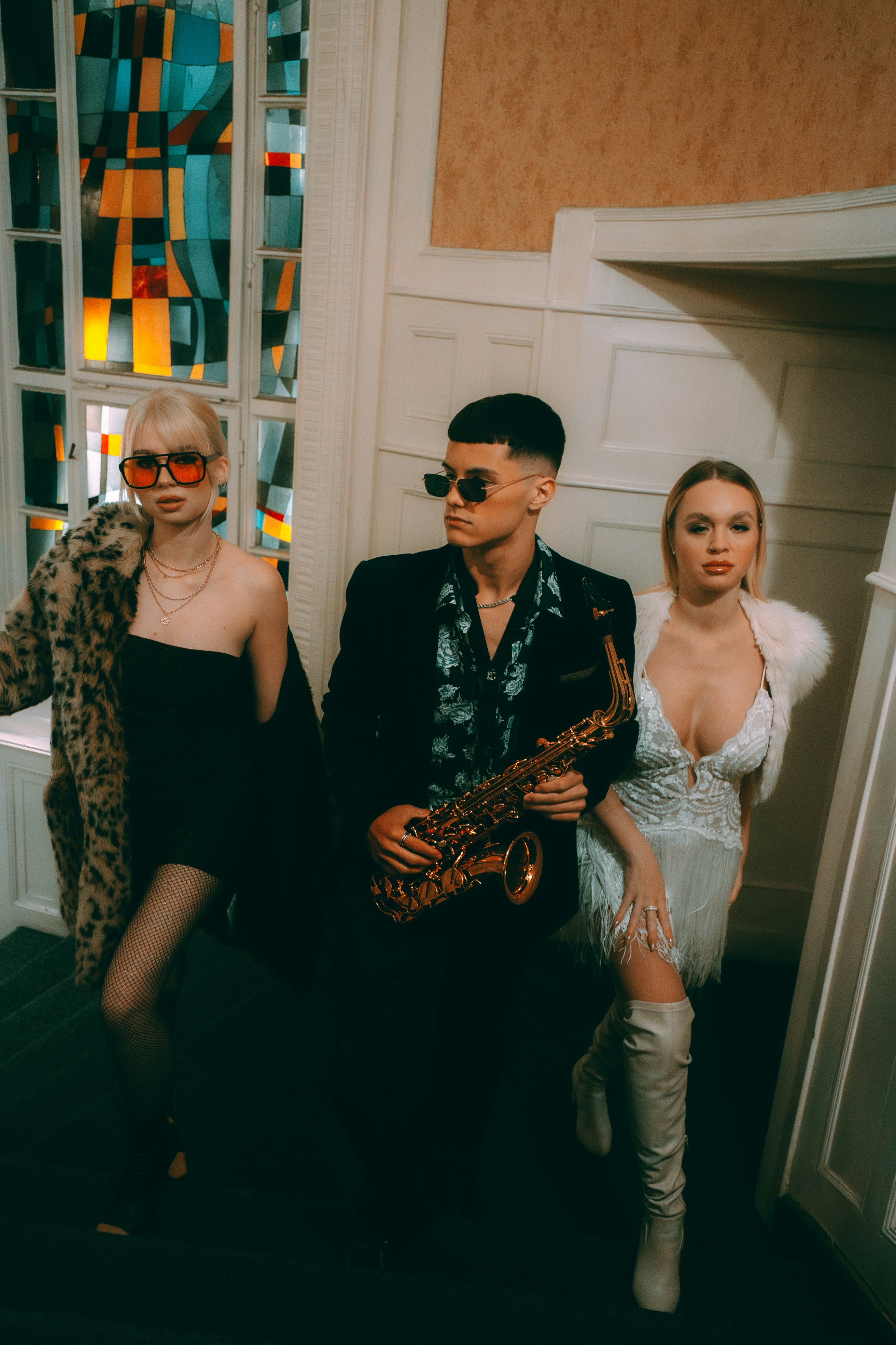 Midnight Syndicate: A saxophonist stands between two glamorous silhouettes