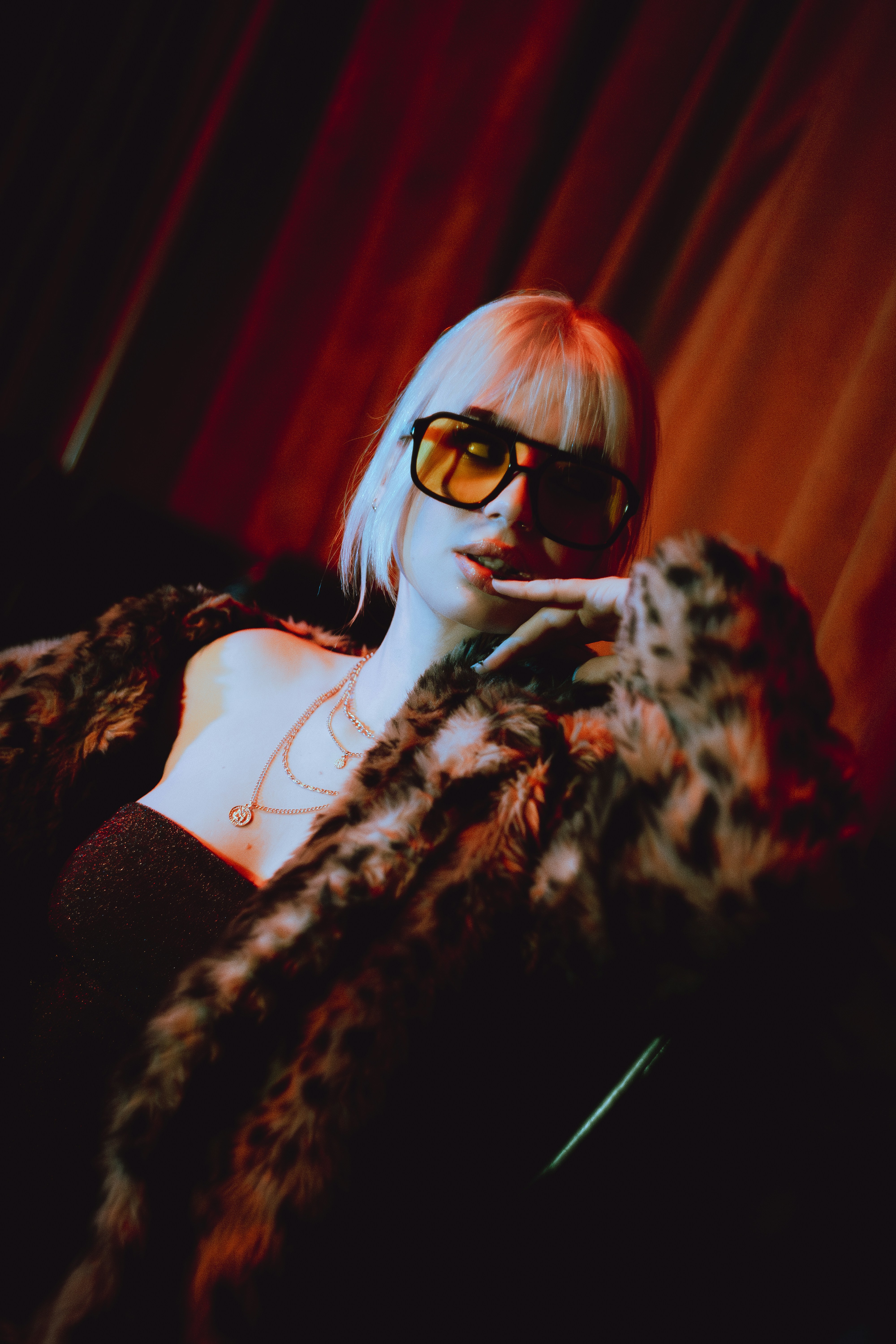 Neon Velvet: Sunglasses and Smoke in the Limelight