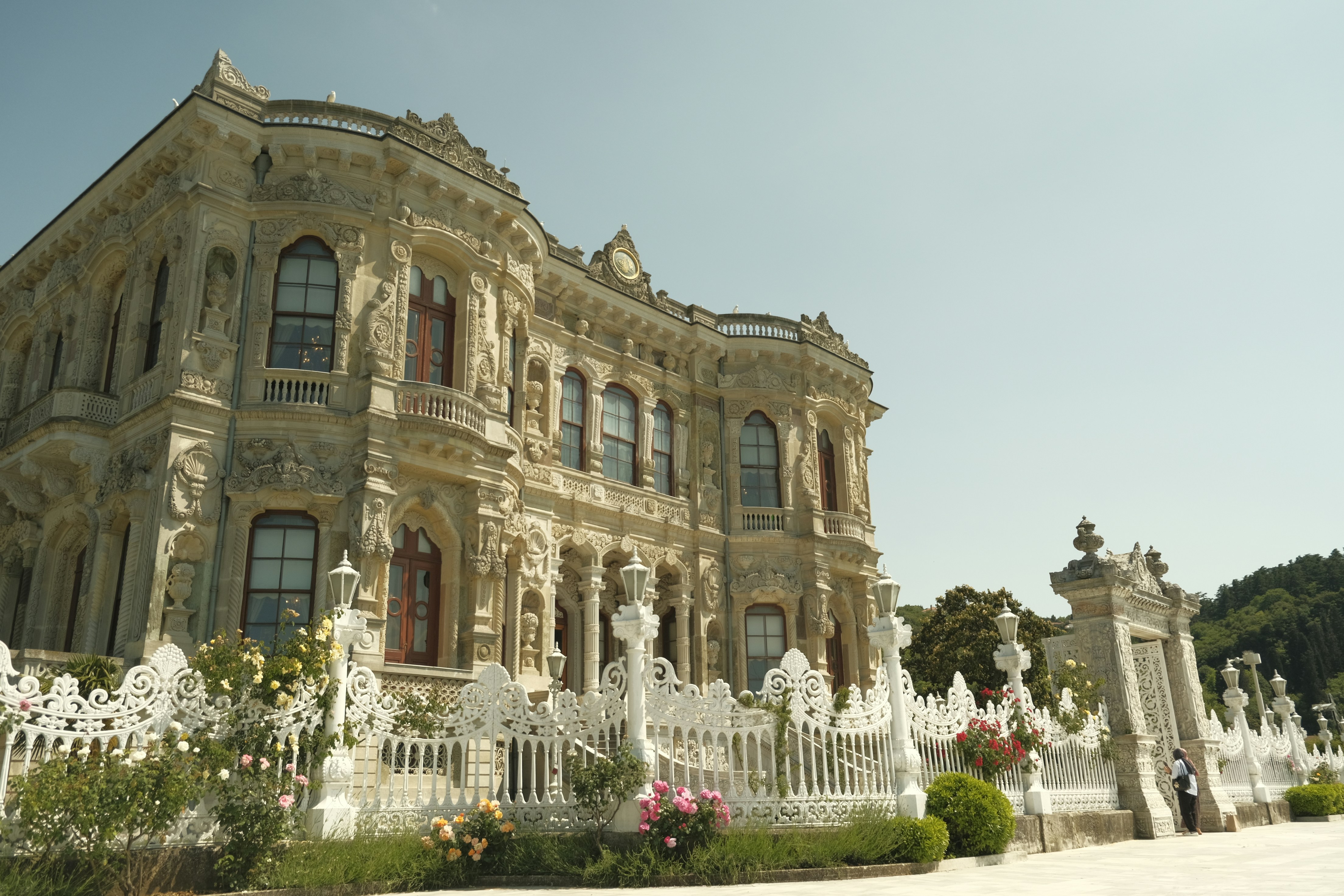 Ornate villa in sunlight: marble façades and decorative balustrades bloom along a grand terrace