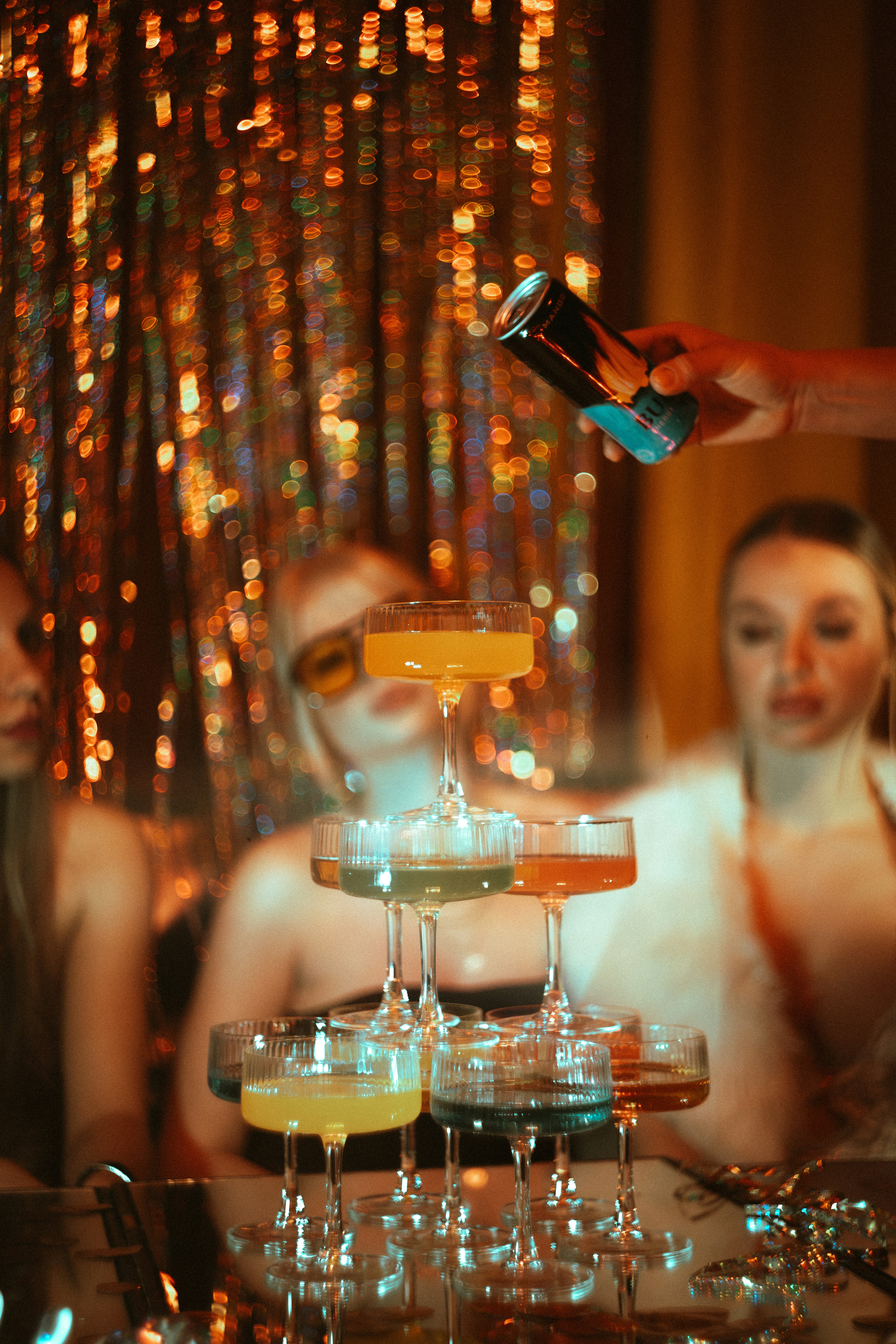 Champagne Cascade: A Tower of Glass under Glittering Backlights