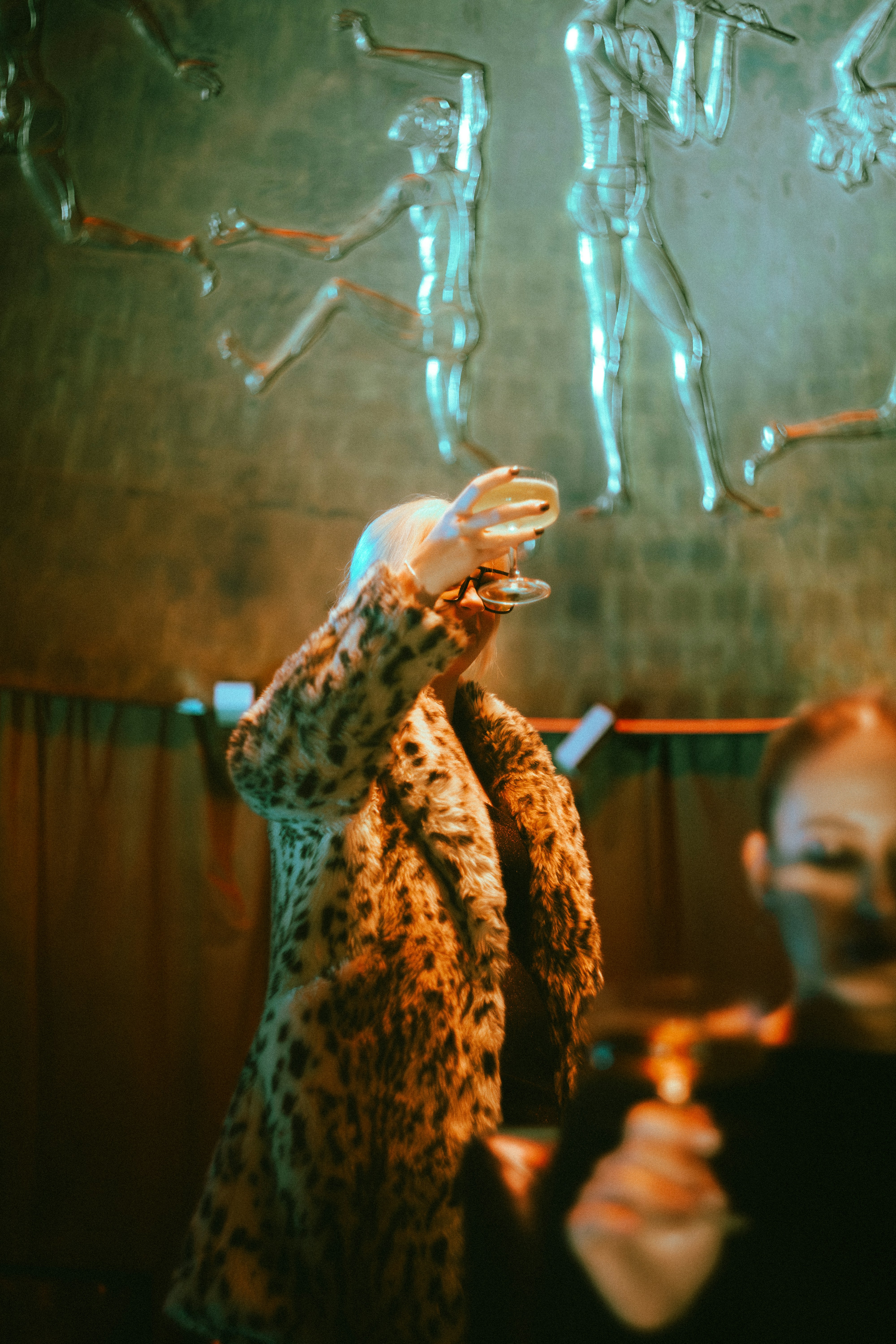 Raised Glass, Raised Night: A Leopard-Print Moment in Warm Neon
