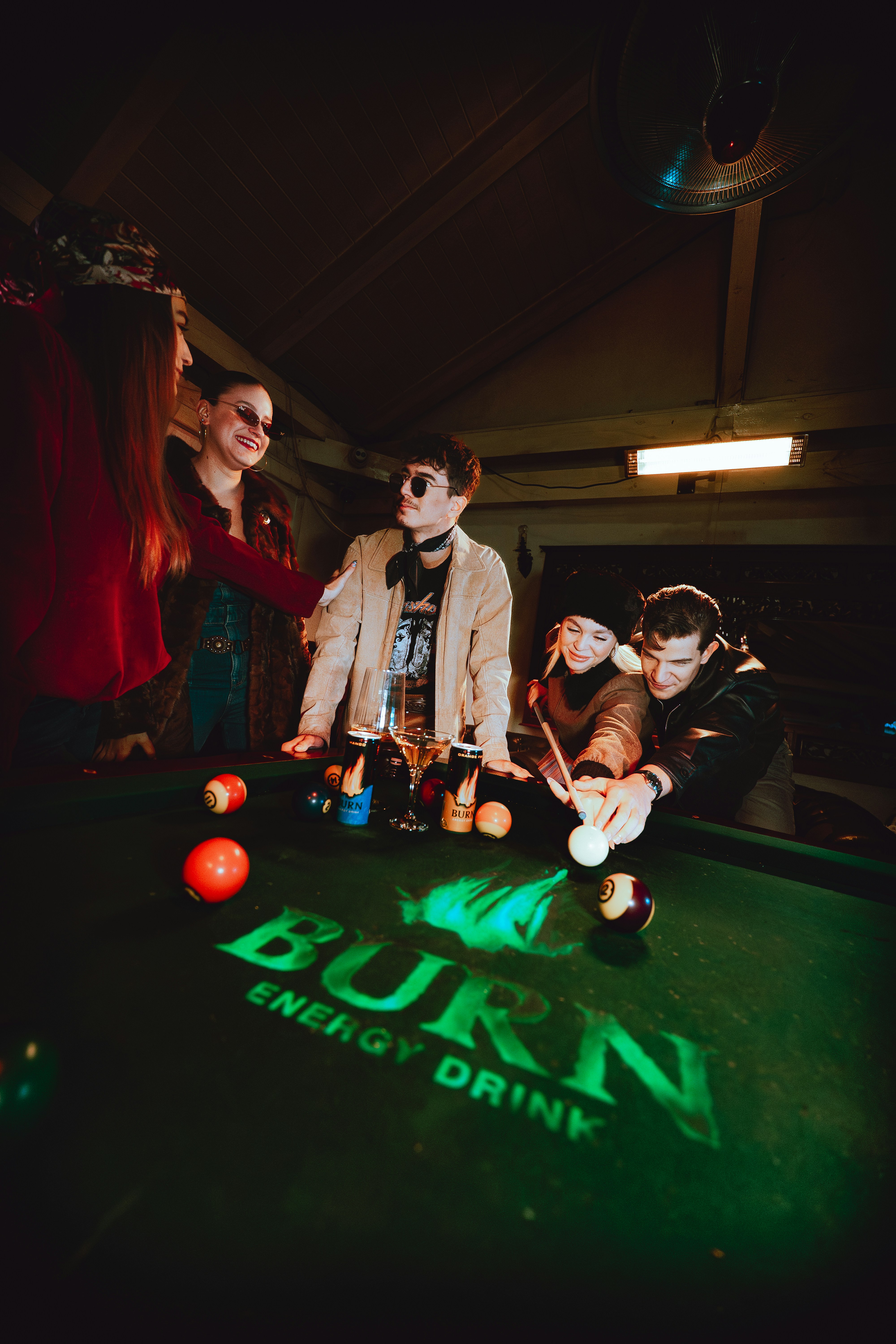 Midnight Break: Friends Rally Around a Pool Table Under Louden Lights