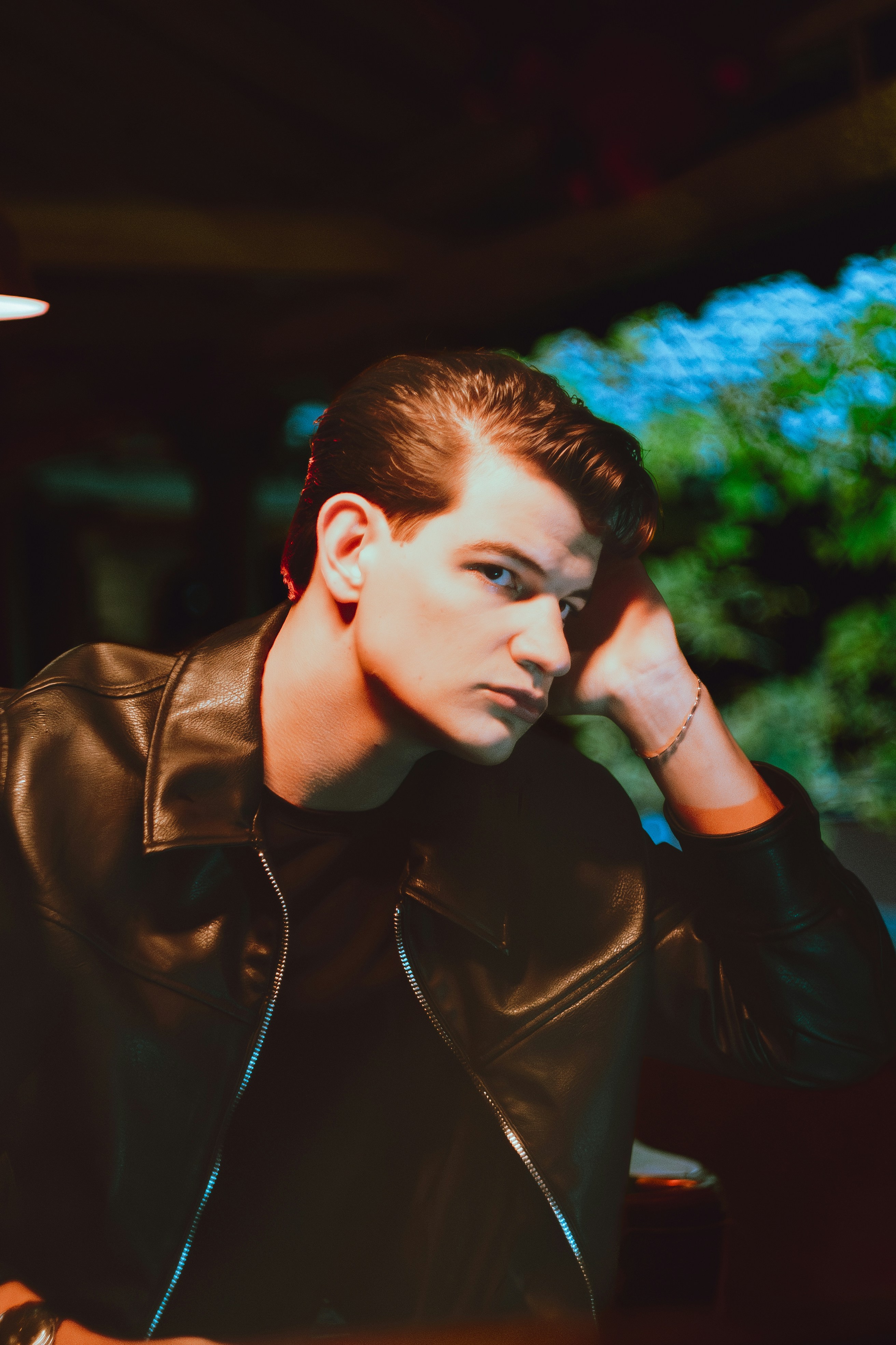 Midnight Quiet: A Leather-Clad Gaze Under Neon Night