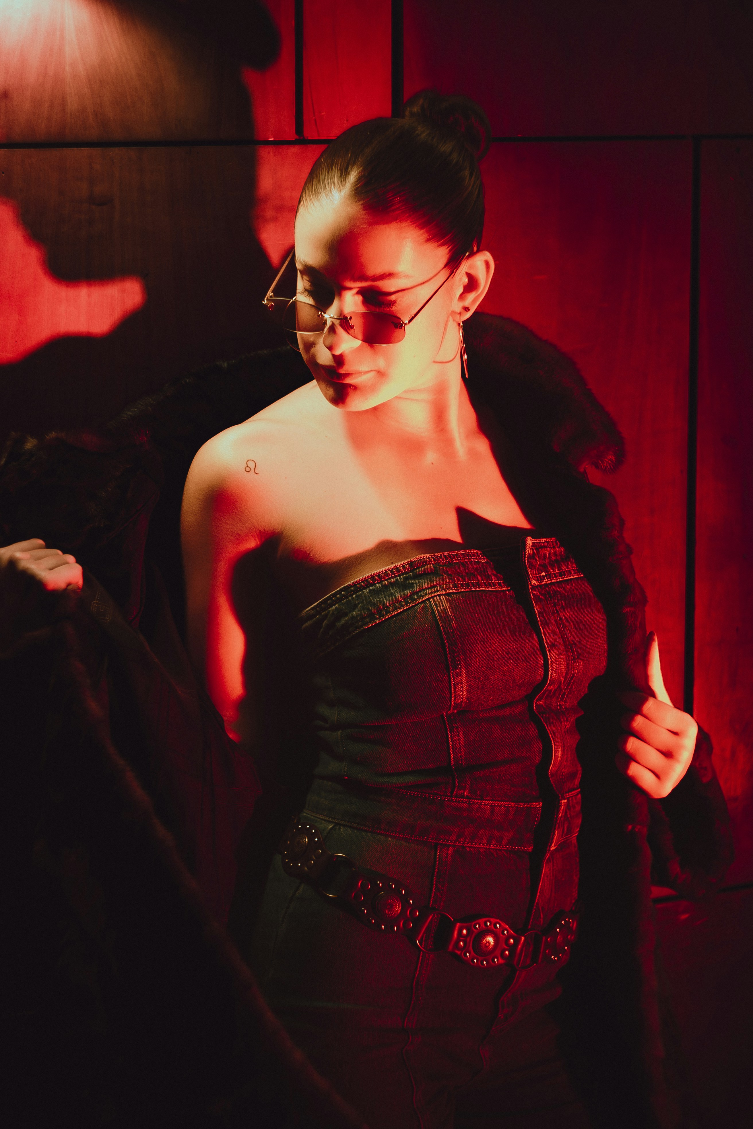 Red Neon Confidence: A Glimpse of Glamour in Shadowed Velvet