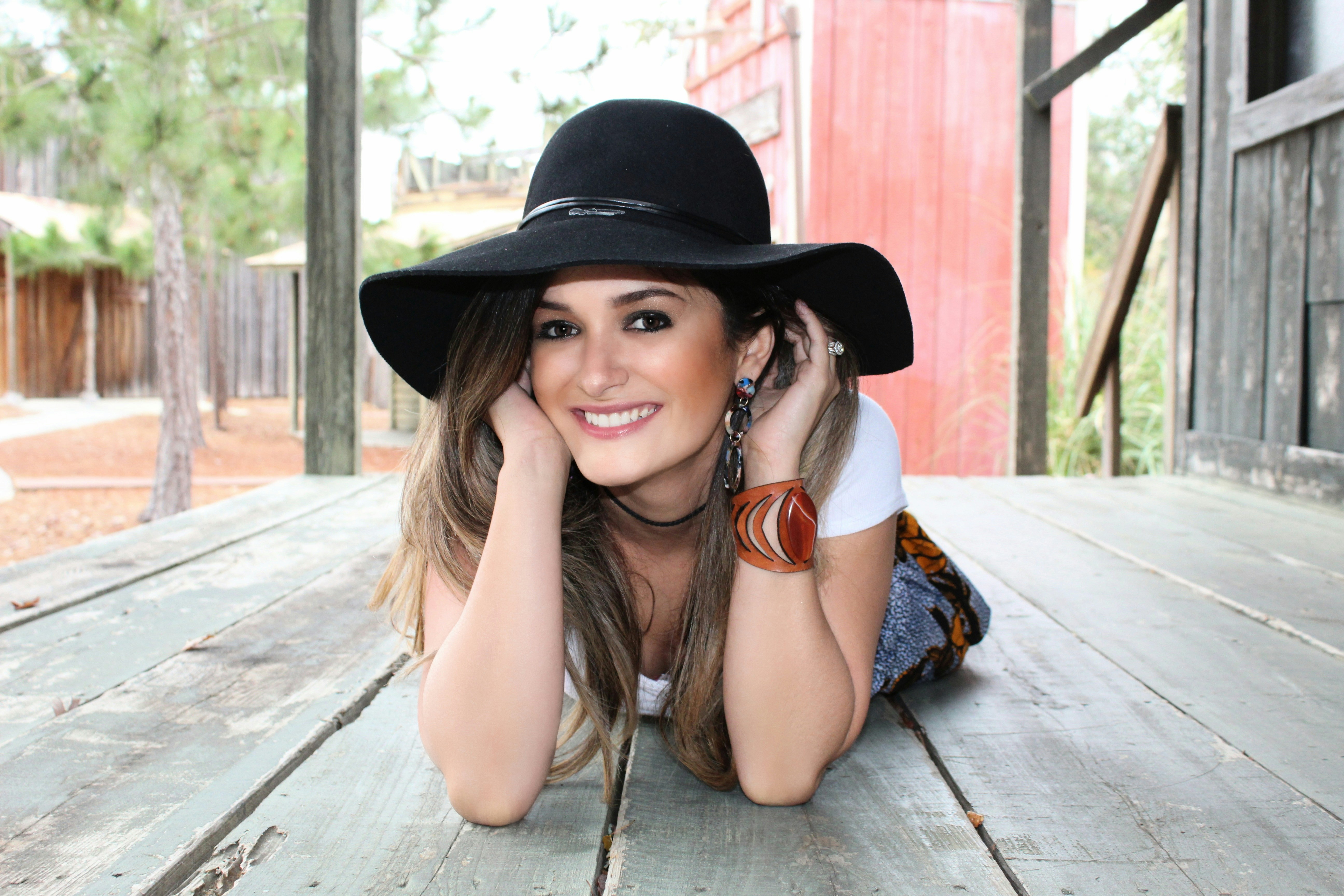 Wide-Brim Confidence: A Laid-Back Portrait on Weathered Wood