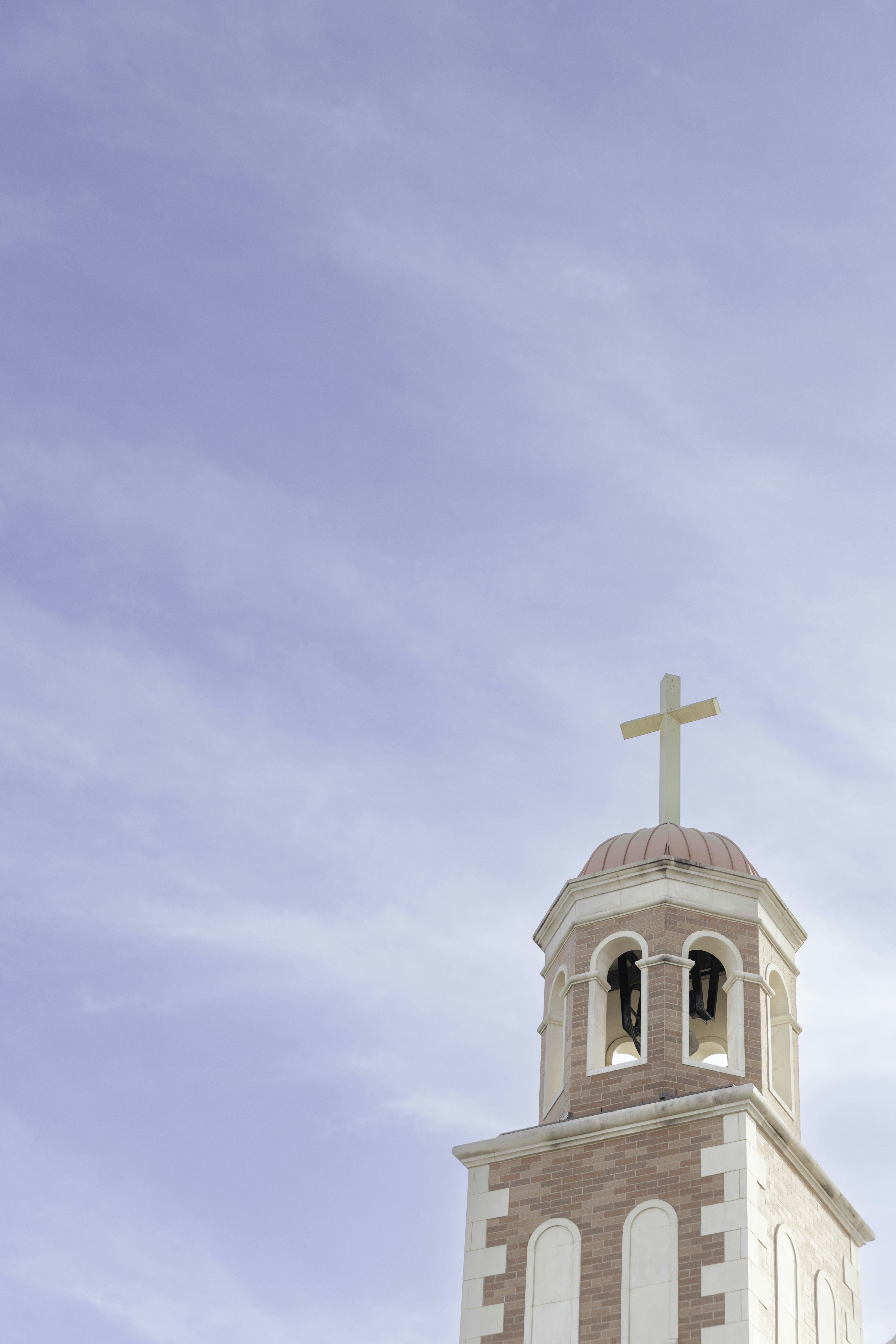 Crossing Bell Tower Under a Pale Sky