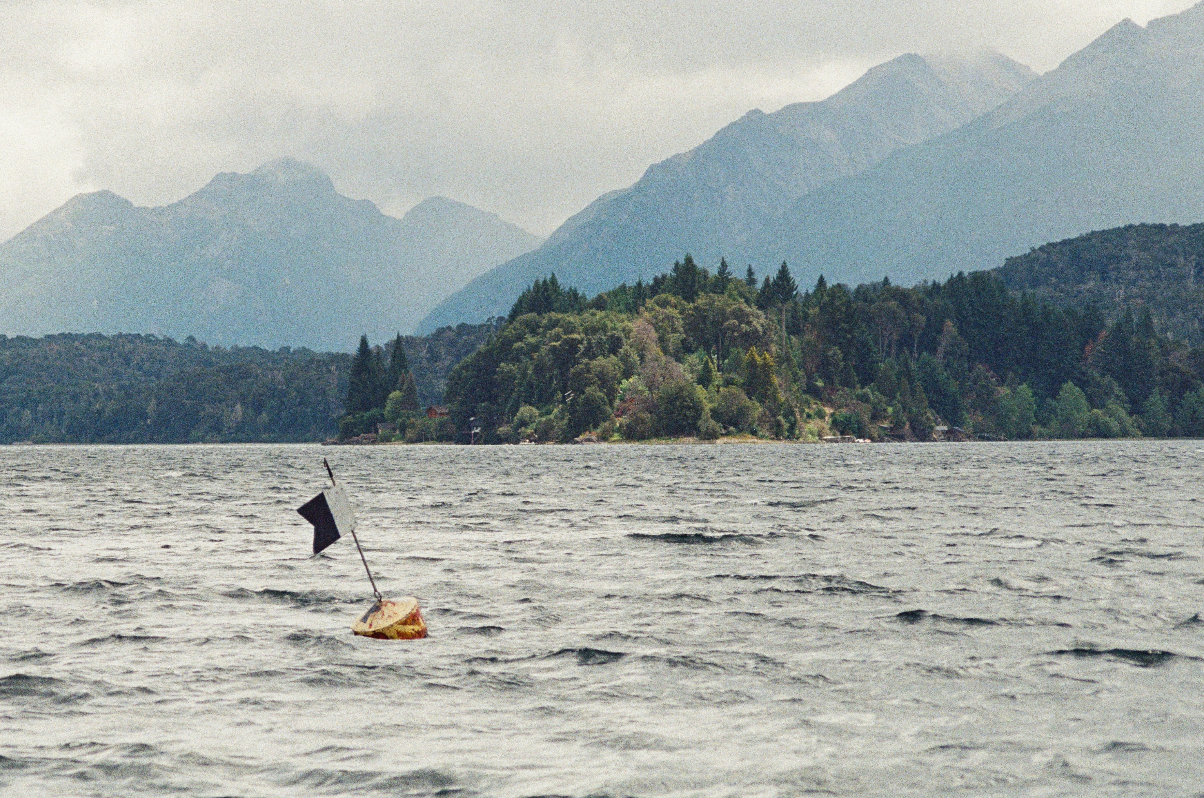 Floating buoy against a mountain lake panorama