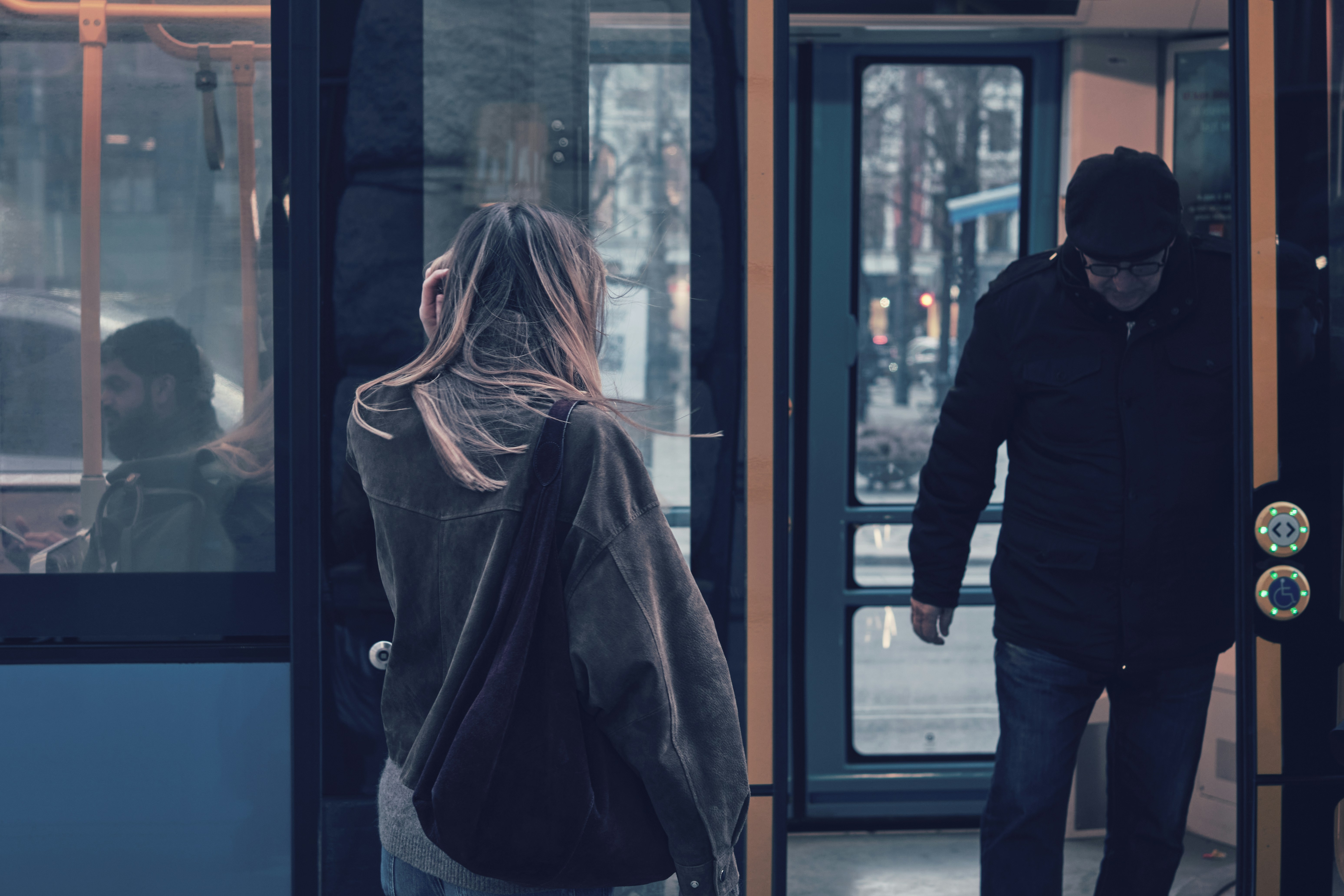 Backlit commuter in a quiet doorway: a glimpse of urban transition