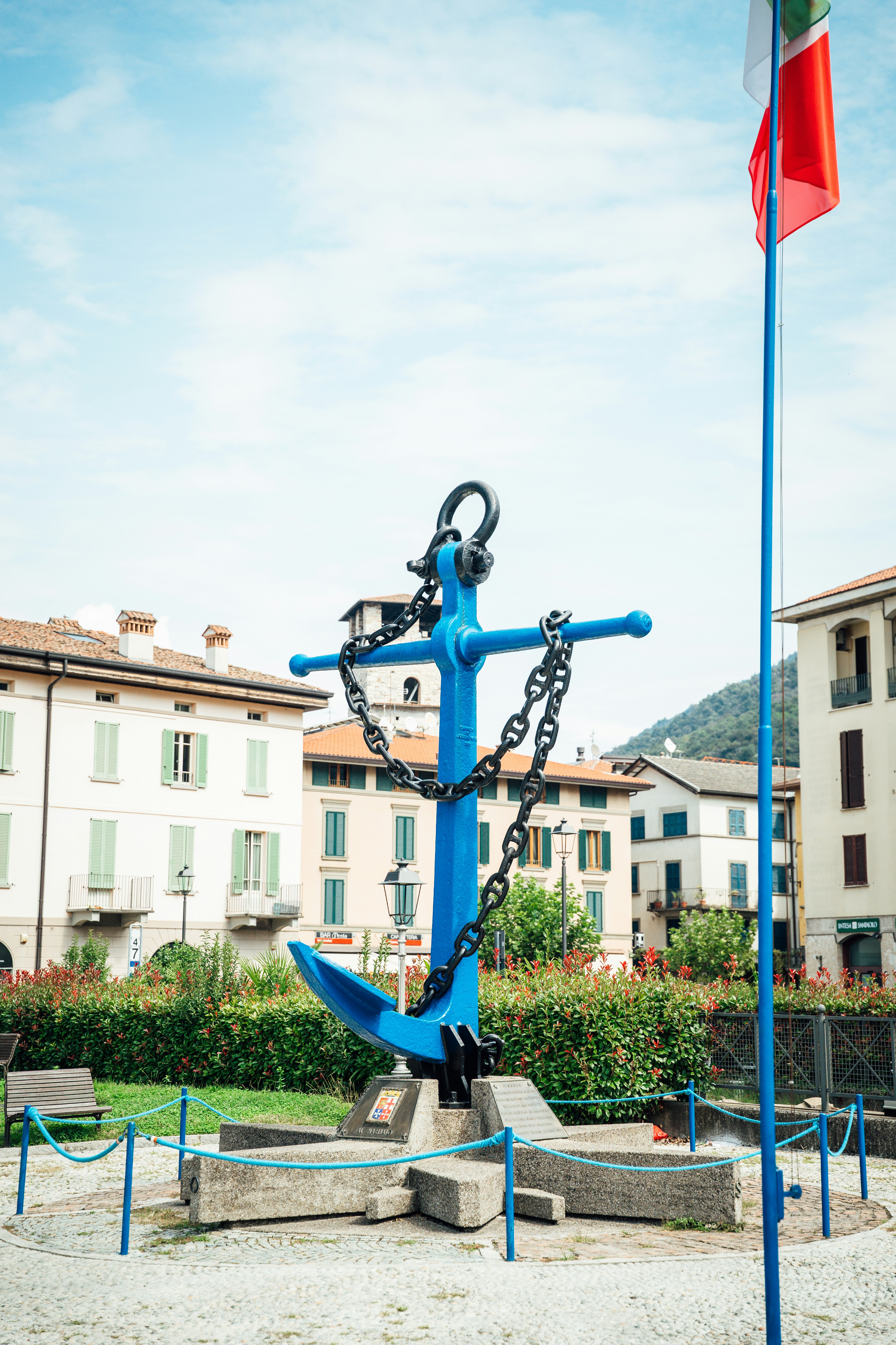 Blue Tide: An Anchor and Italian Flag in a Quiet Square