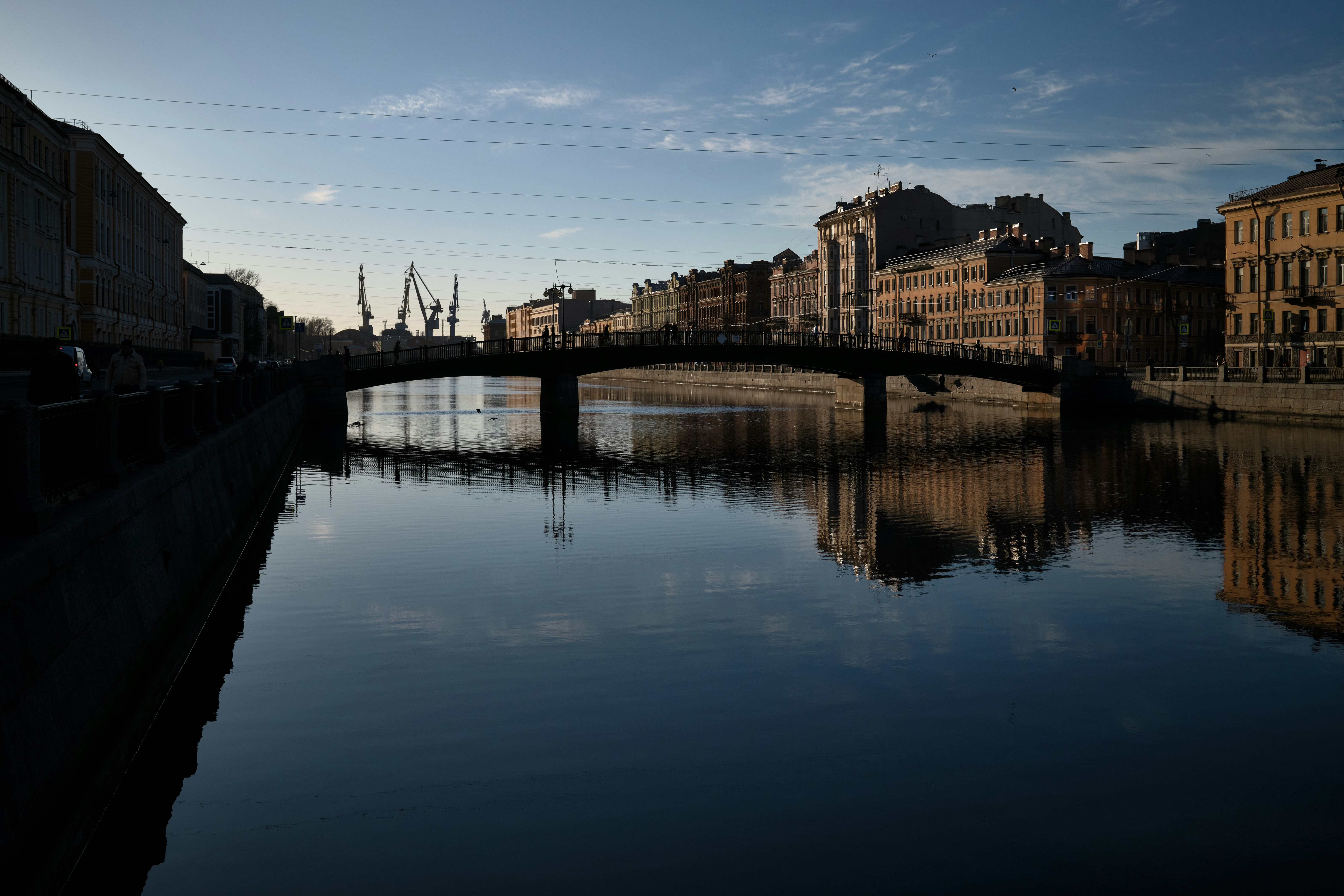 Bridge over a Quiet City River at Dusk