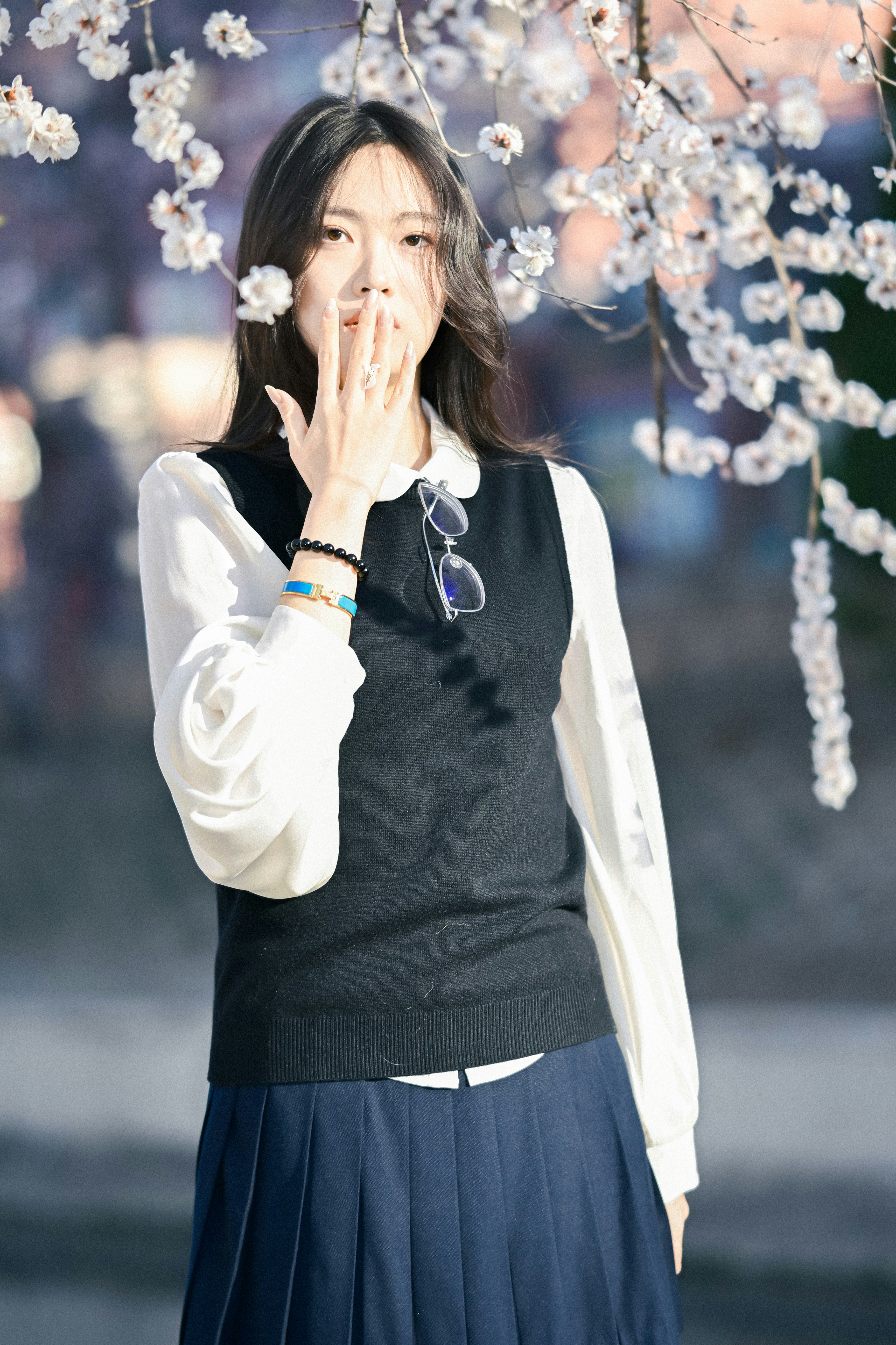 Young woman in school uniform with cherry blossoms