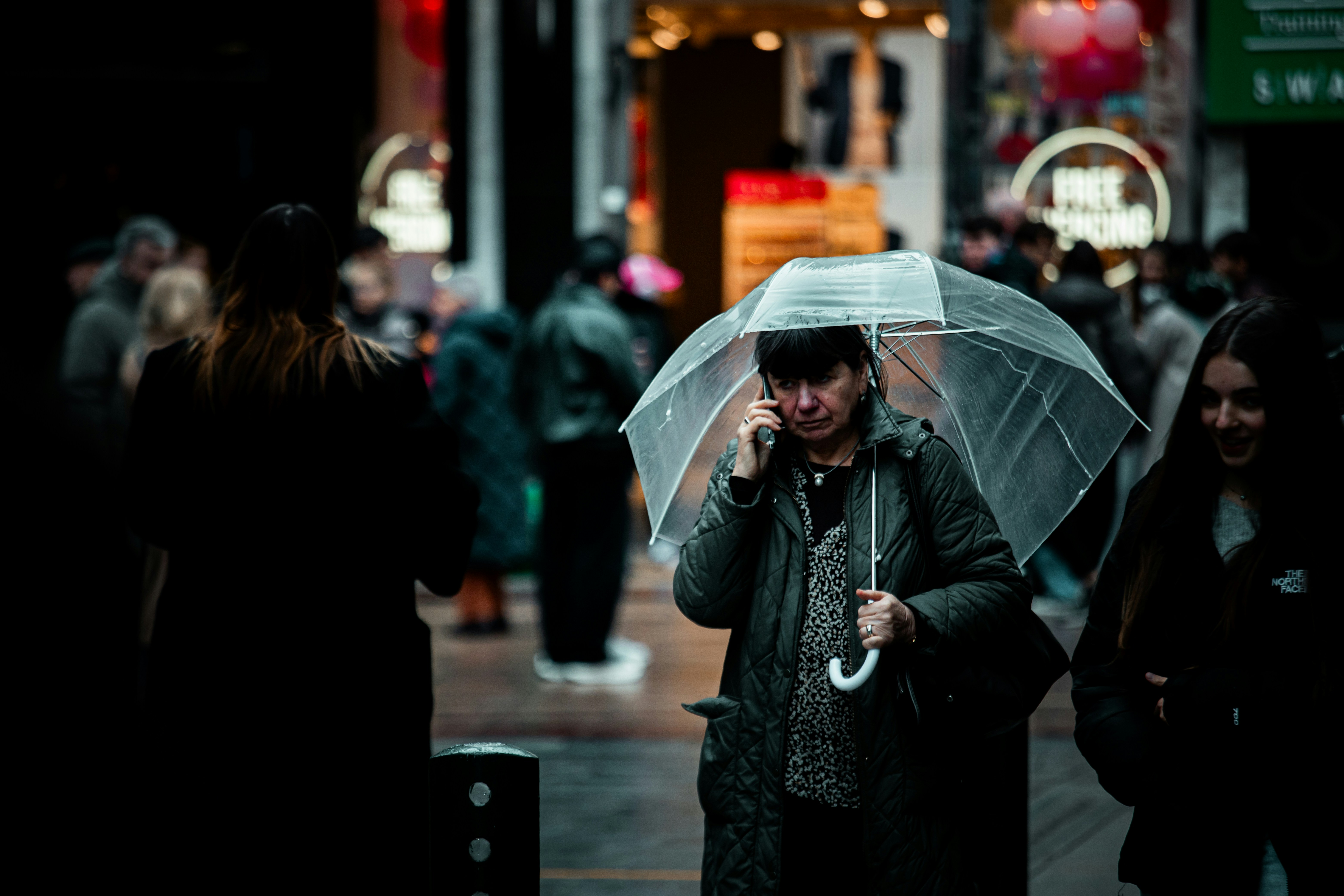 Umbrella of Moments: A Silent Exchange on a Neon Street