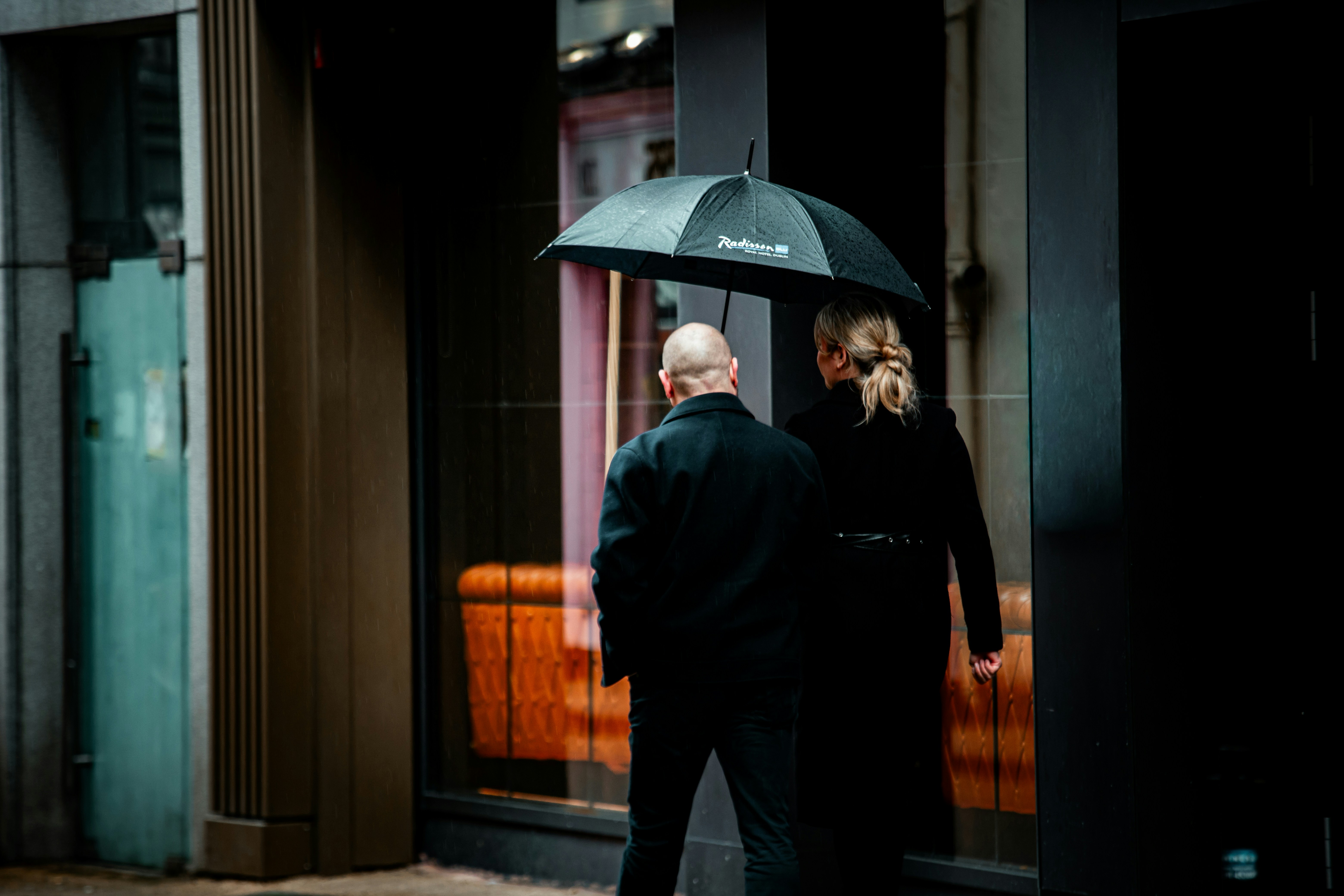 Umbrella rendezvous on a rain-kissed city street