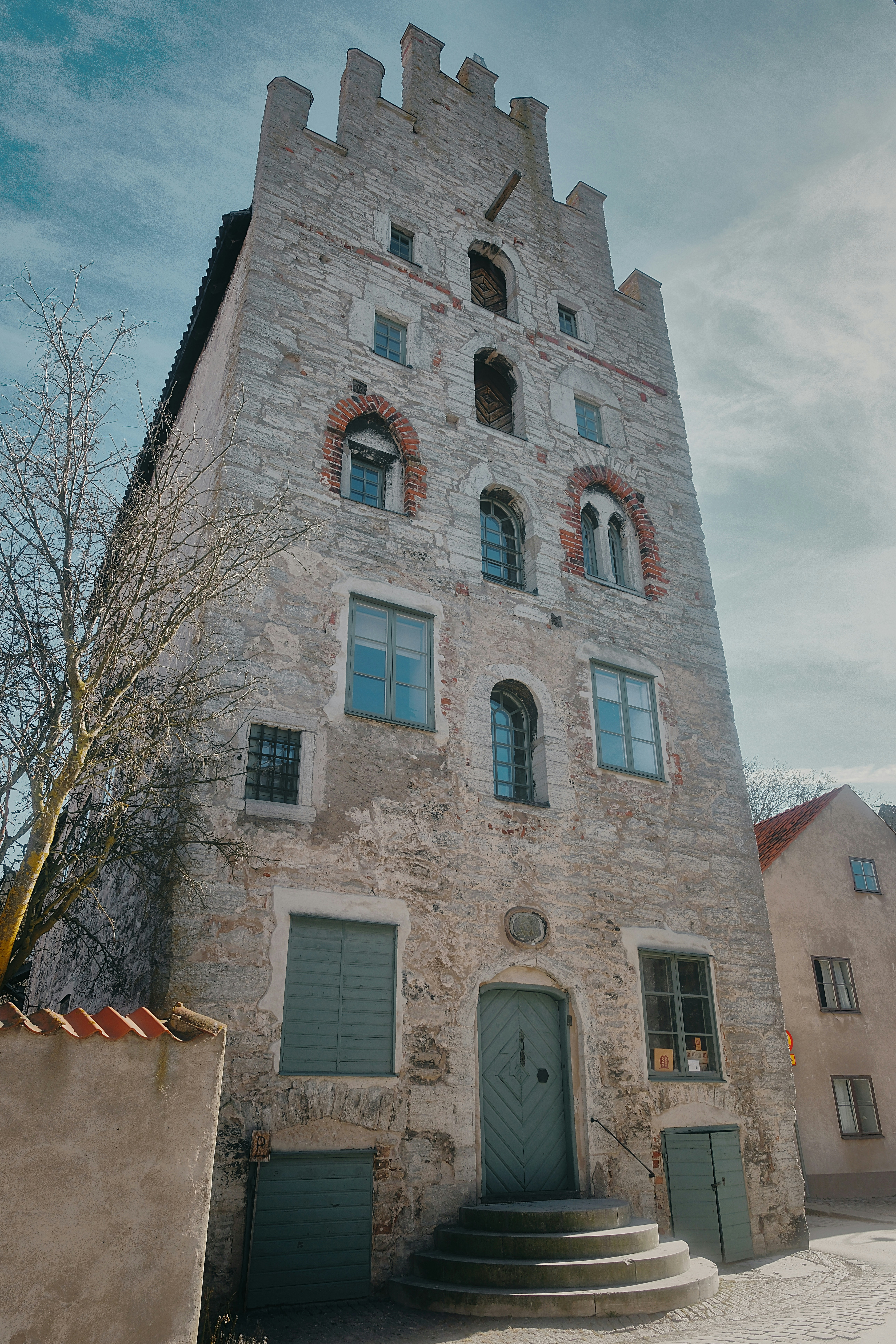Castle Tower in the Sun: A Weathered Facade Reaching the Sky