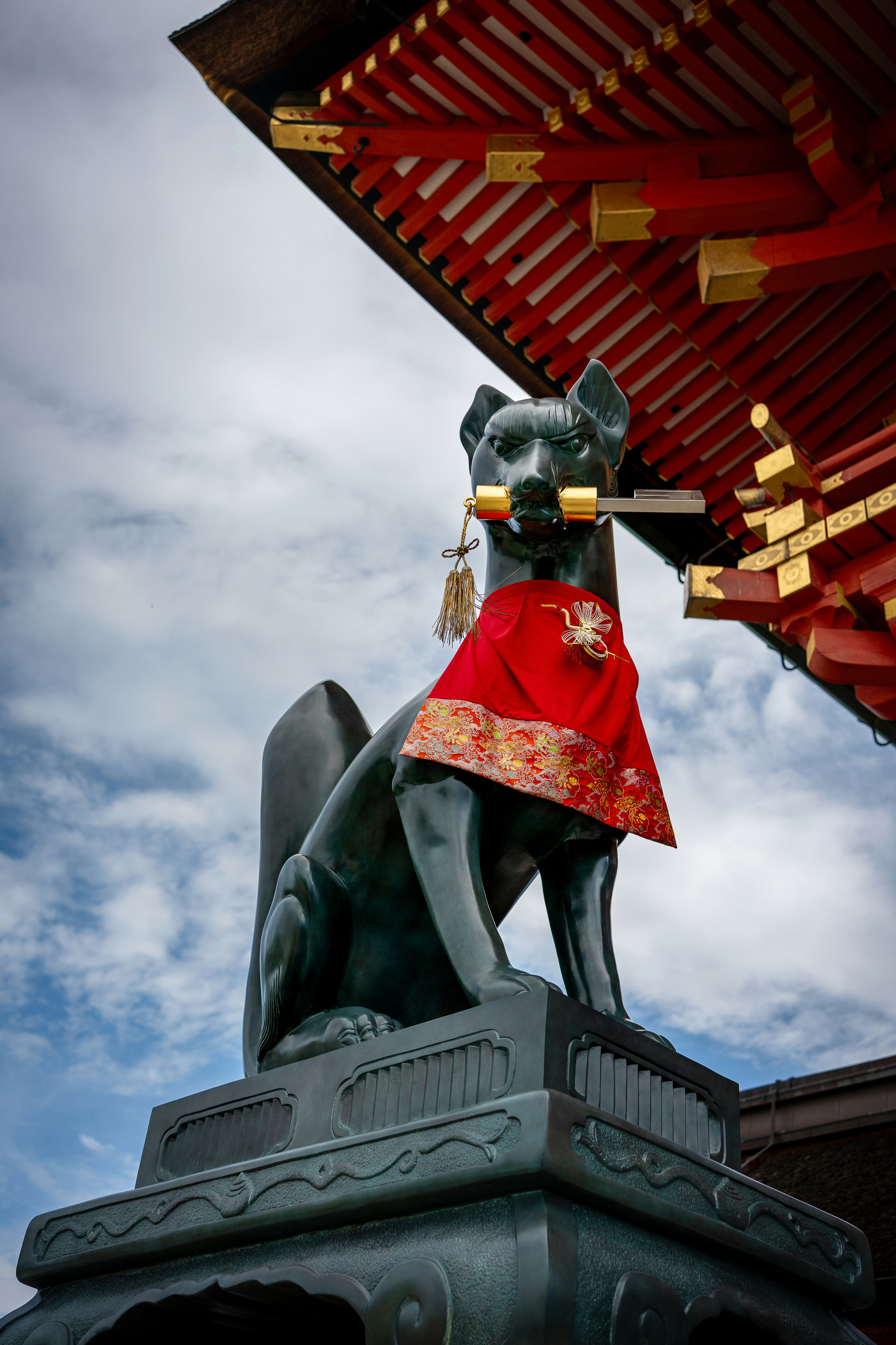 Guardian Fox in Red Vest at a Temple Gate