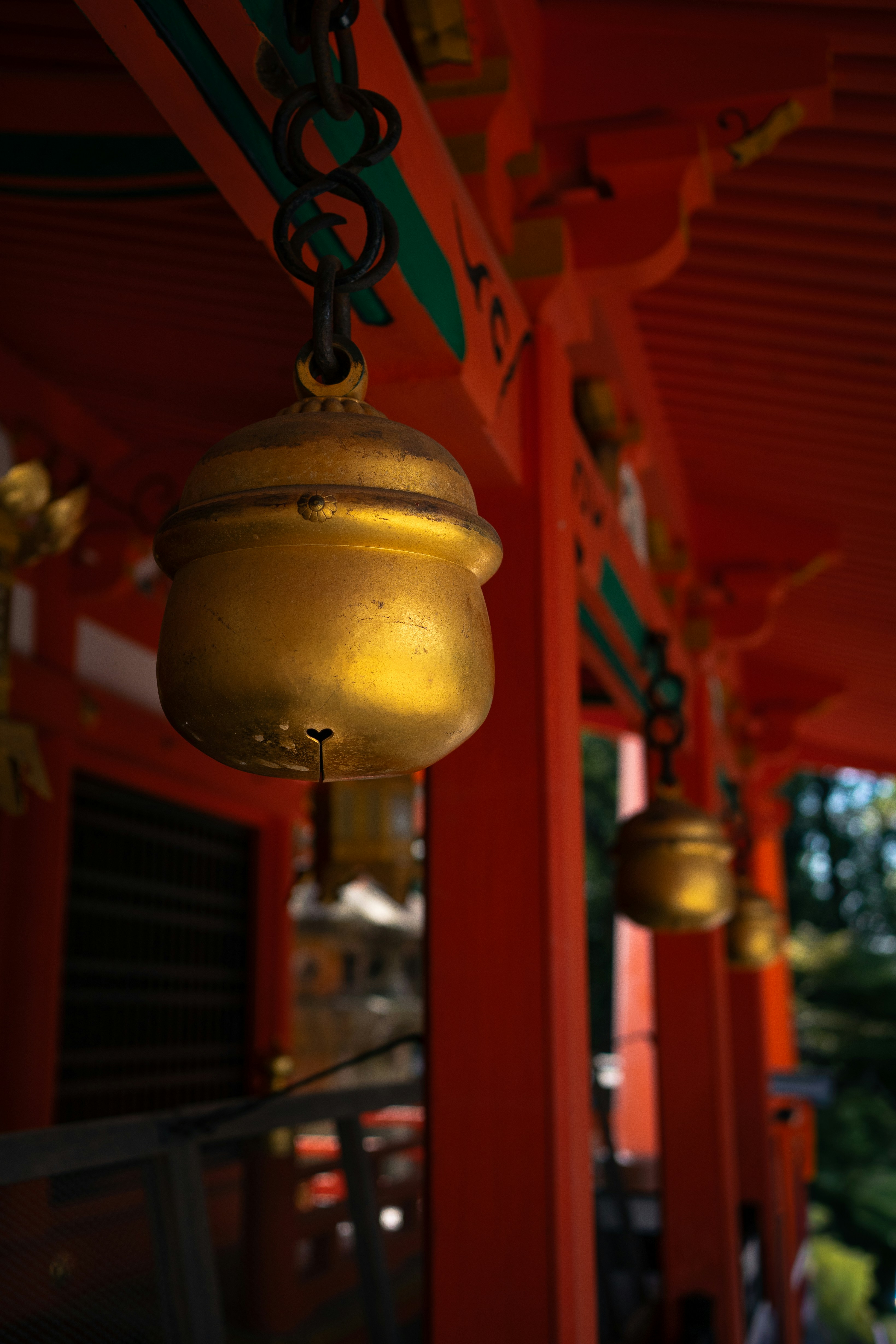Golden Bell in Red Corridor: A Quiet Moment in a Shrine