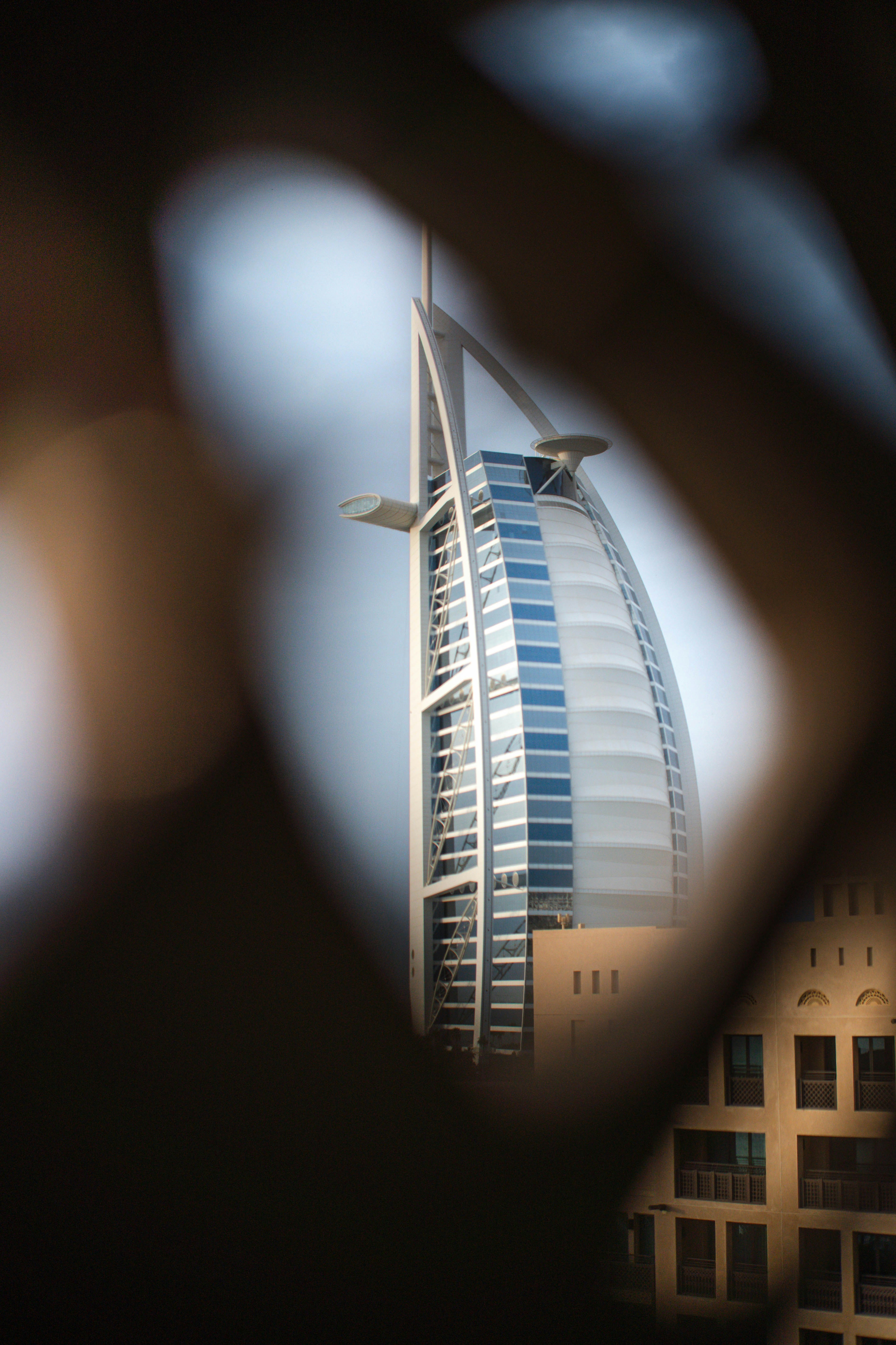 Gilded Archways: Burj Al Arab Peeking Through a Framed Vista