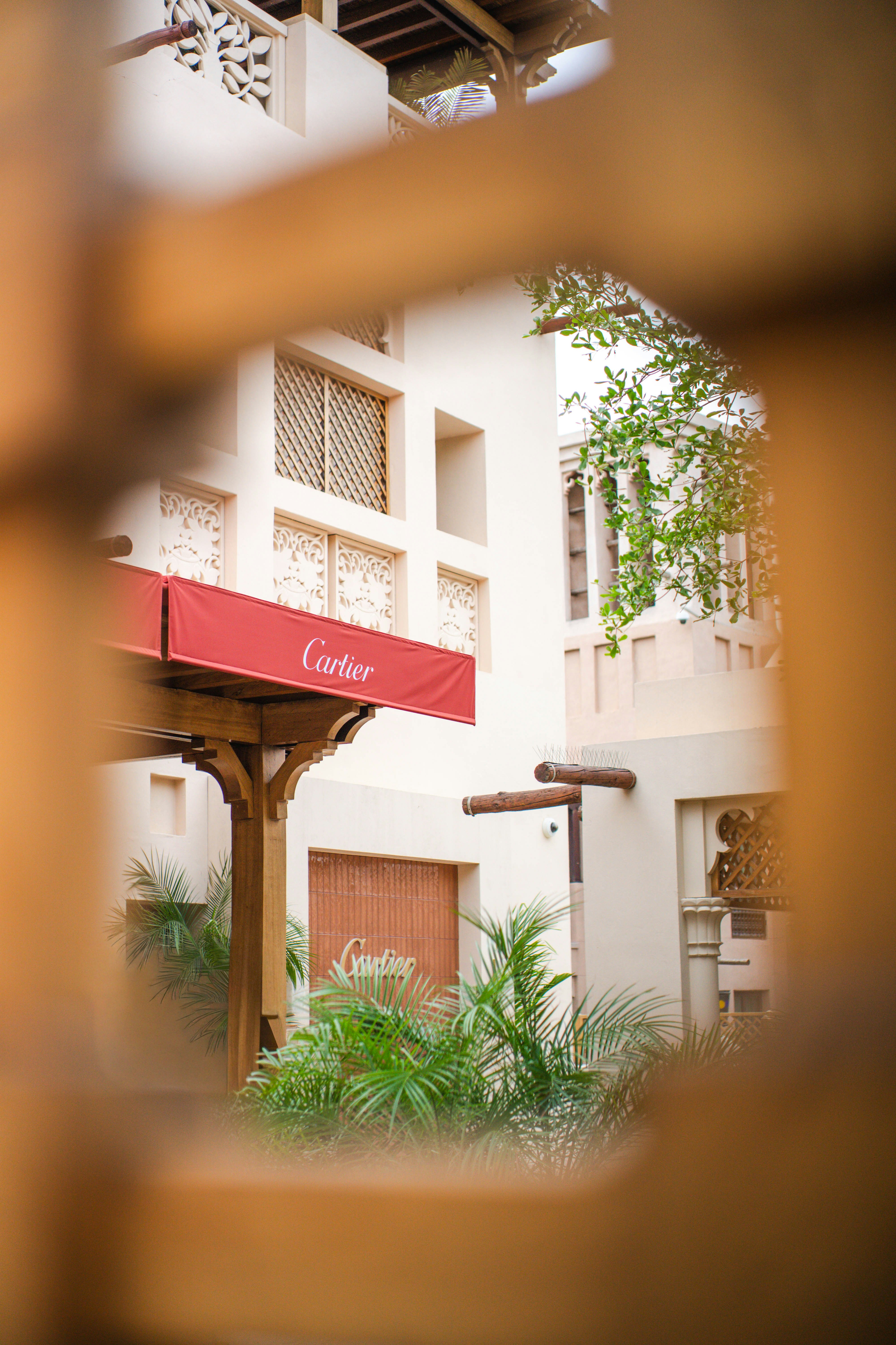 Cartier Courtyard Through a Lattice of Warm Iron