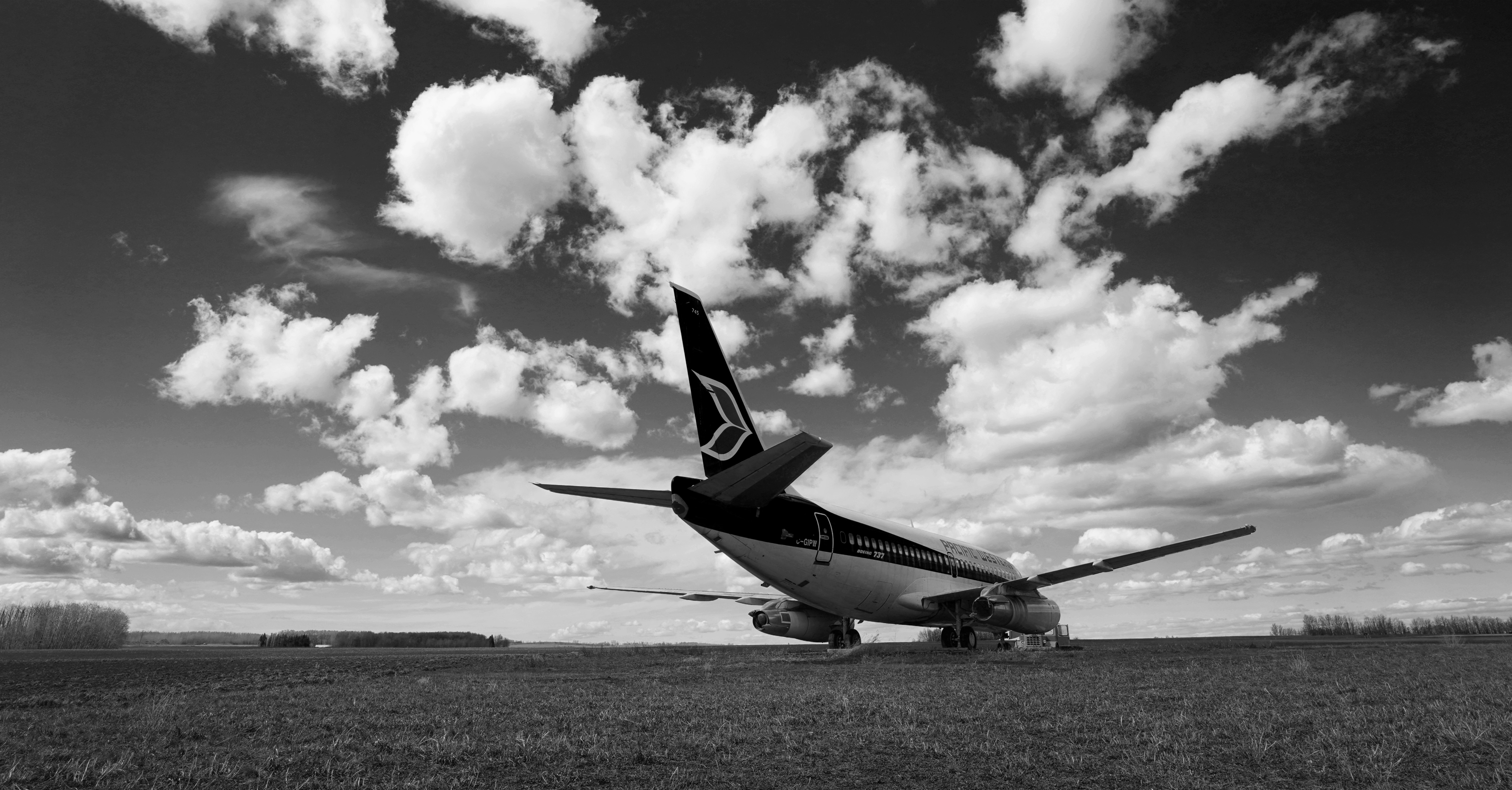 Grounded Giant: A Lone Jet Resting on a Wind-Swept Field