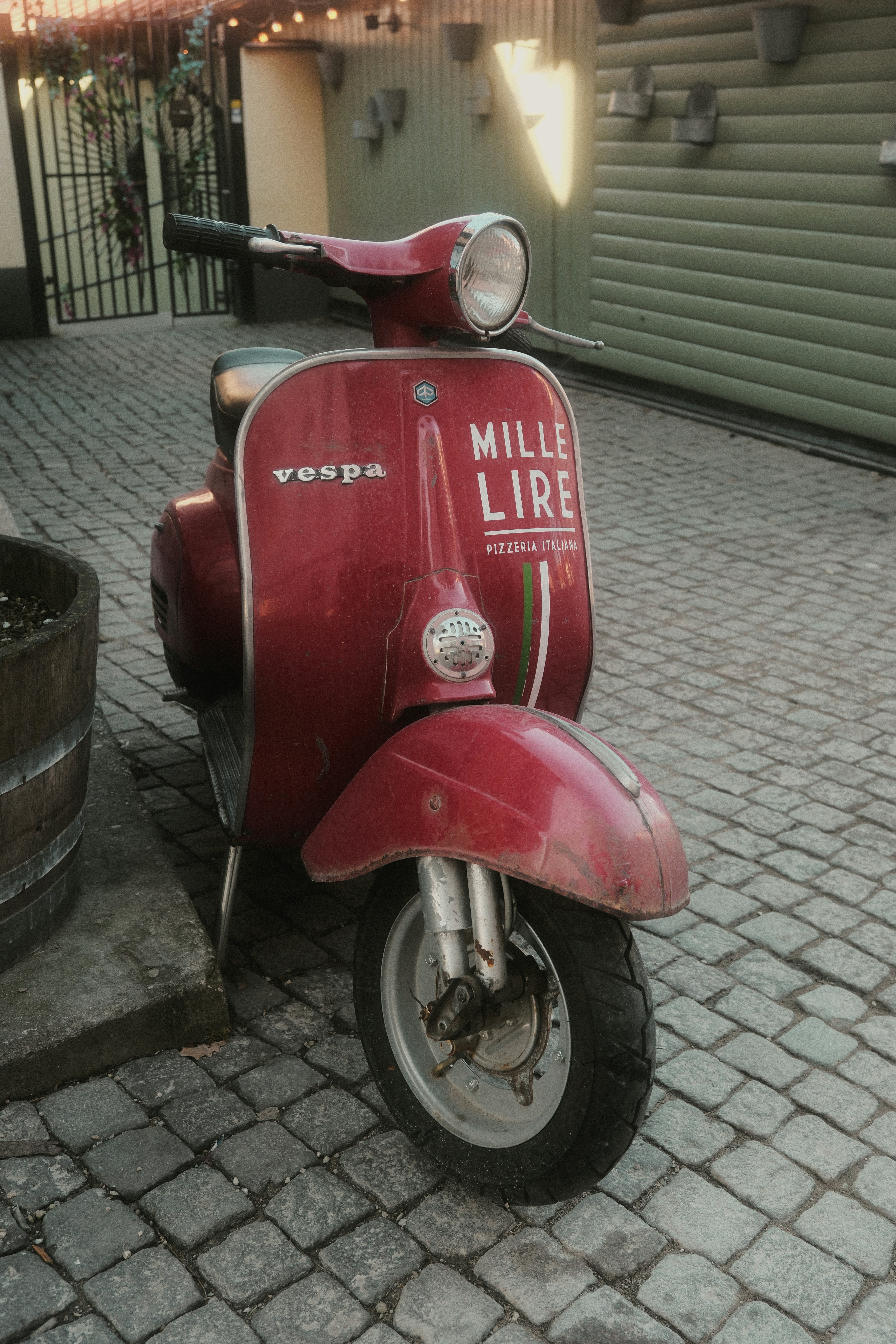 Red Vespa Stranger in the Cobblestone Square
