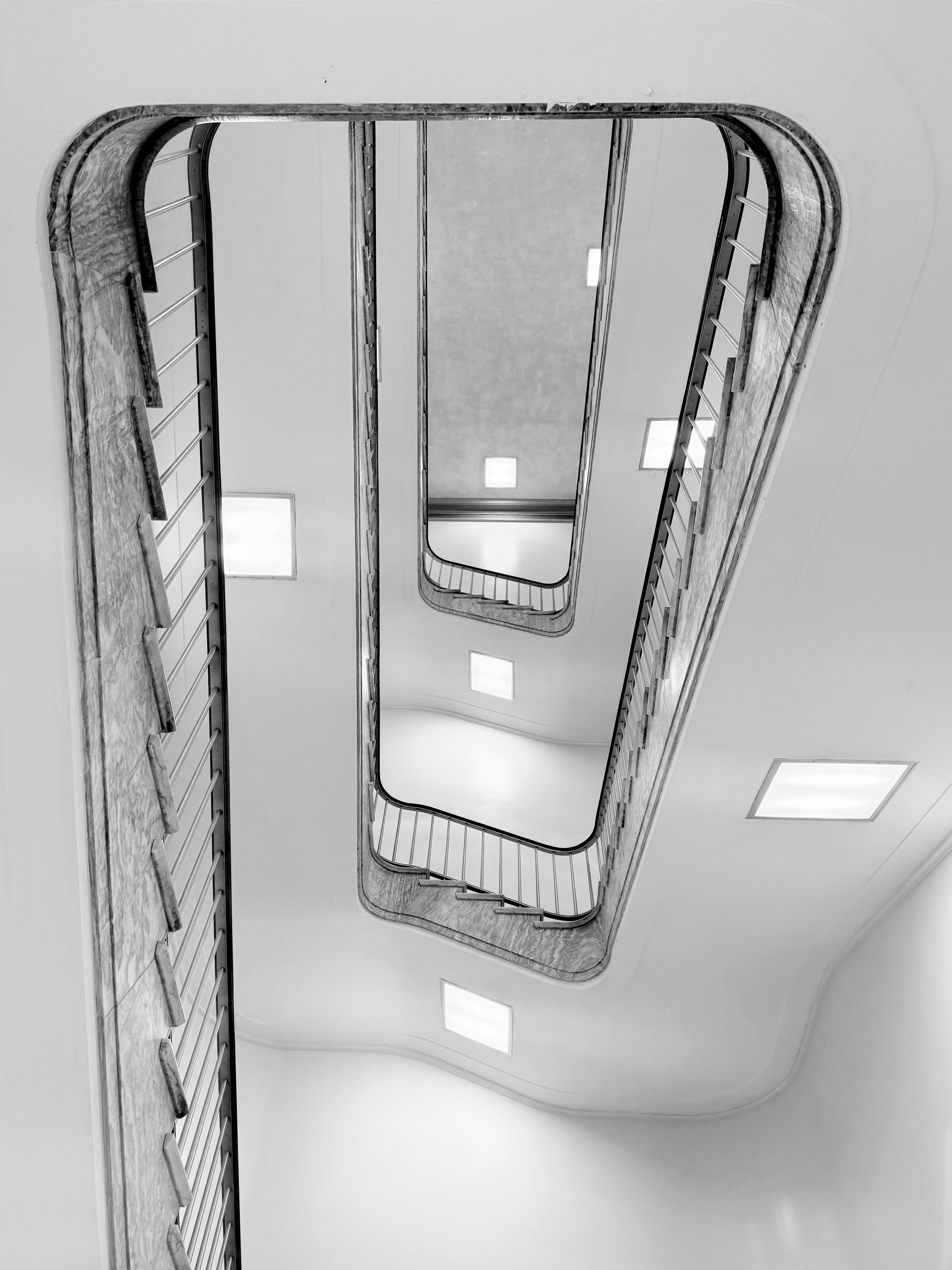 Spiral Atrium: A Monochrome Descent Through Layers of Light