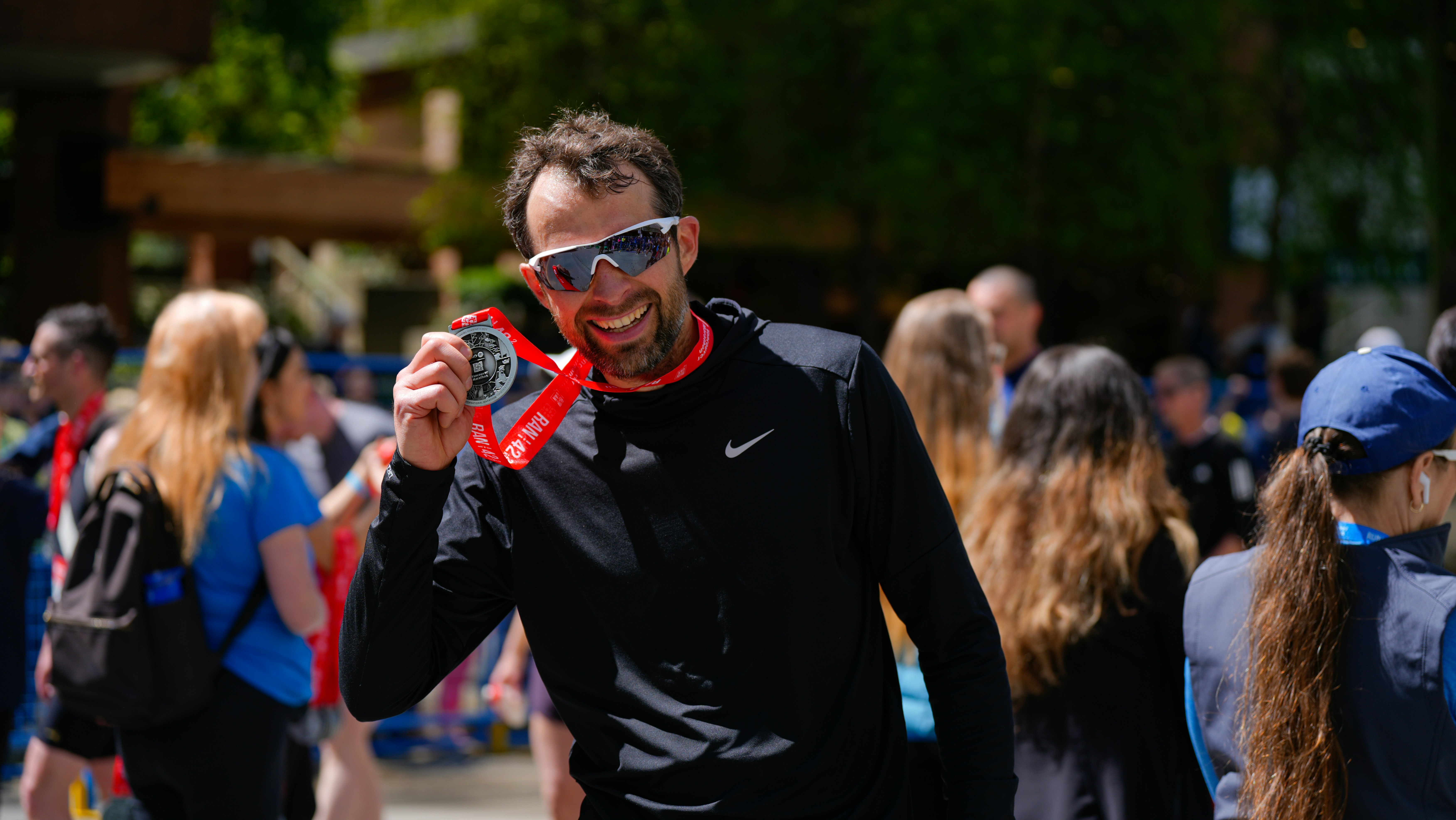 Champion with a Crimson Medal: A Victory Moment Amidst the Crowd