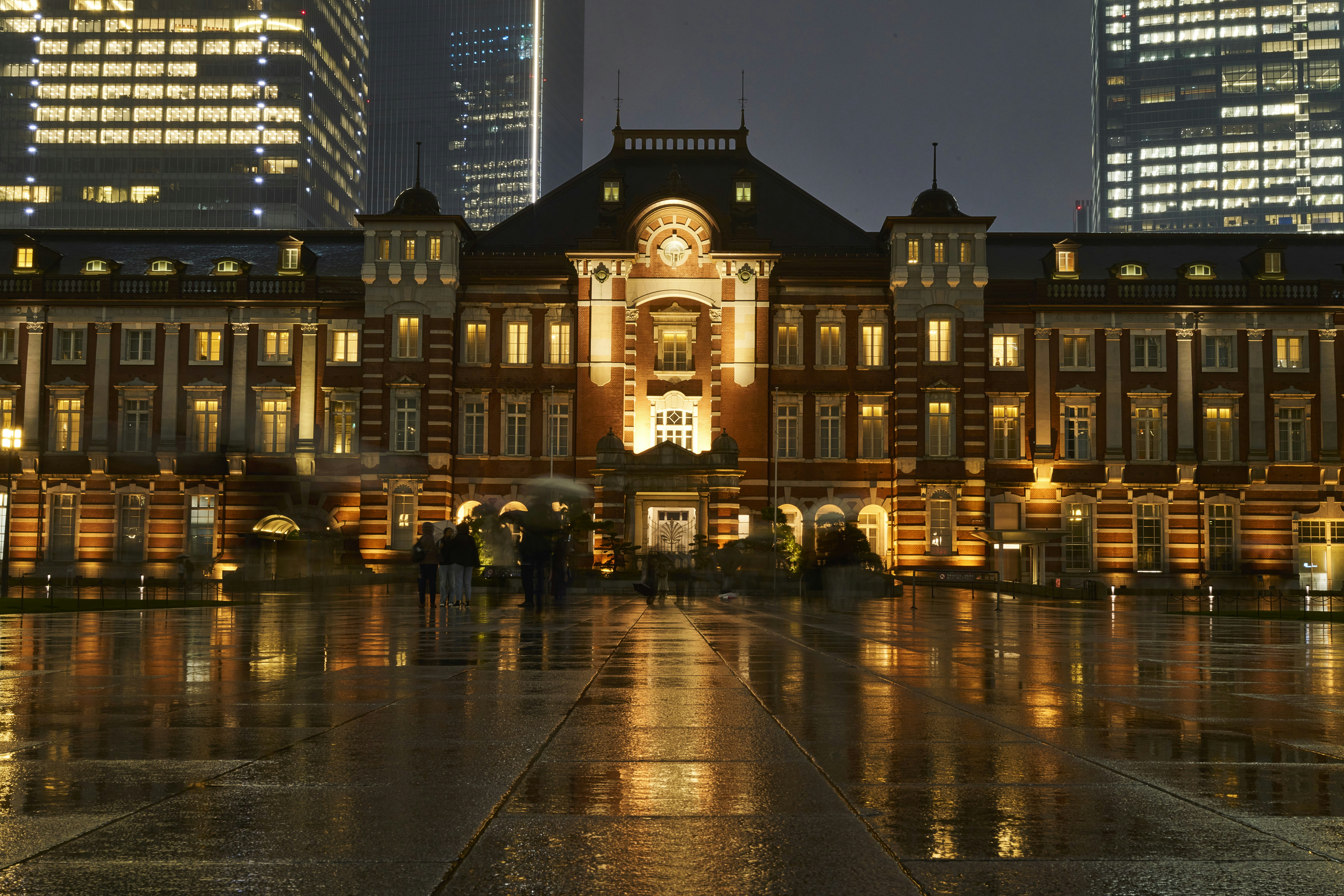 A Lantern-Lit Facade: Tokyo Station at Night Reflected
