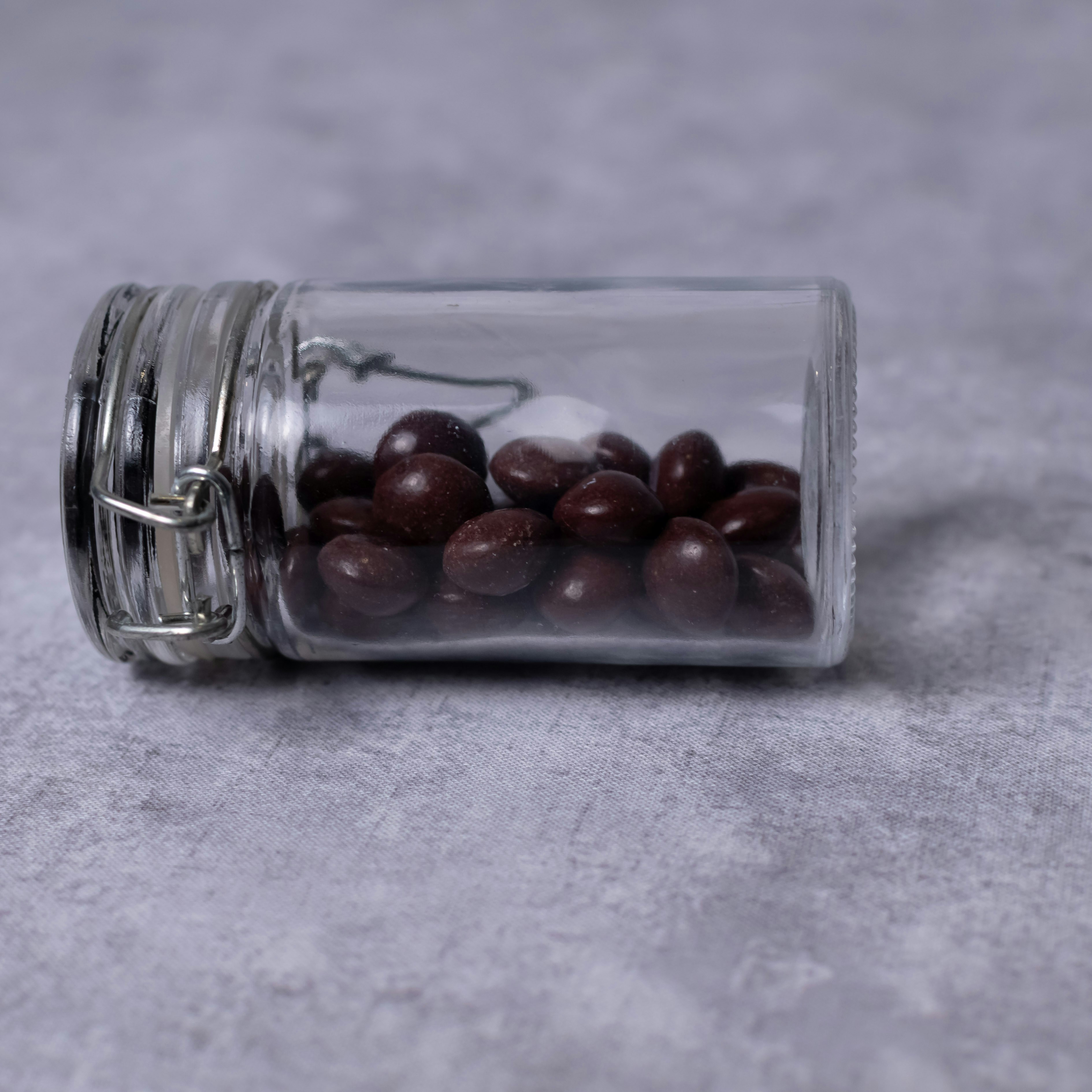 Tiny Glass Jar of Red Seeds: A Quiet Still Life