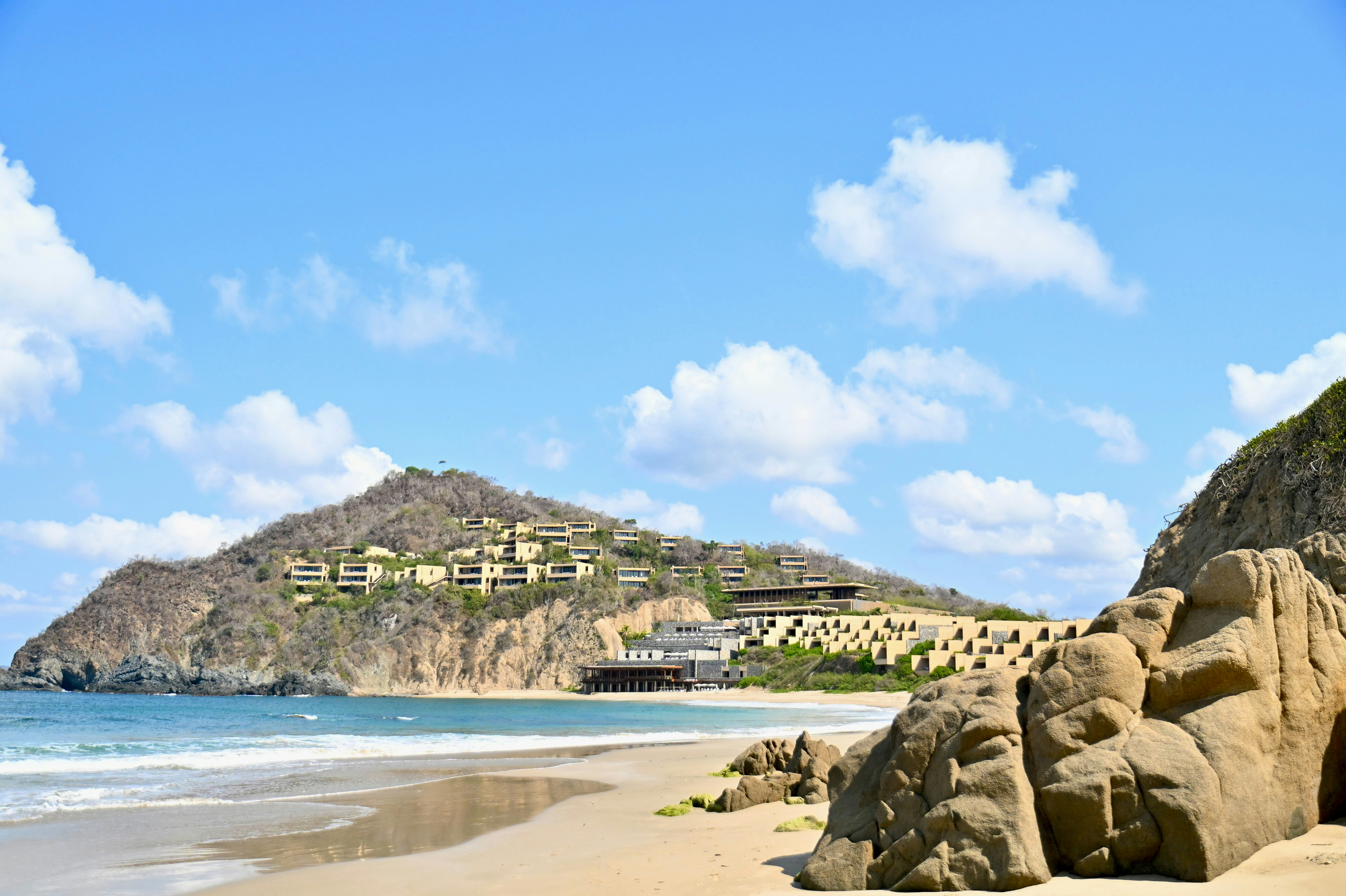 Coastal Haven: Terraced Dwellings Nestle into a Rocky Promontory