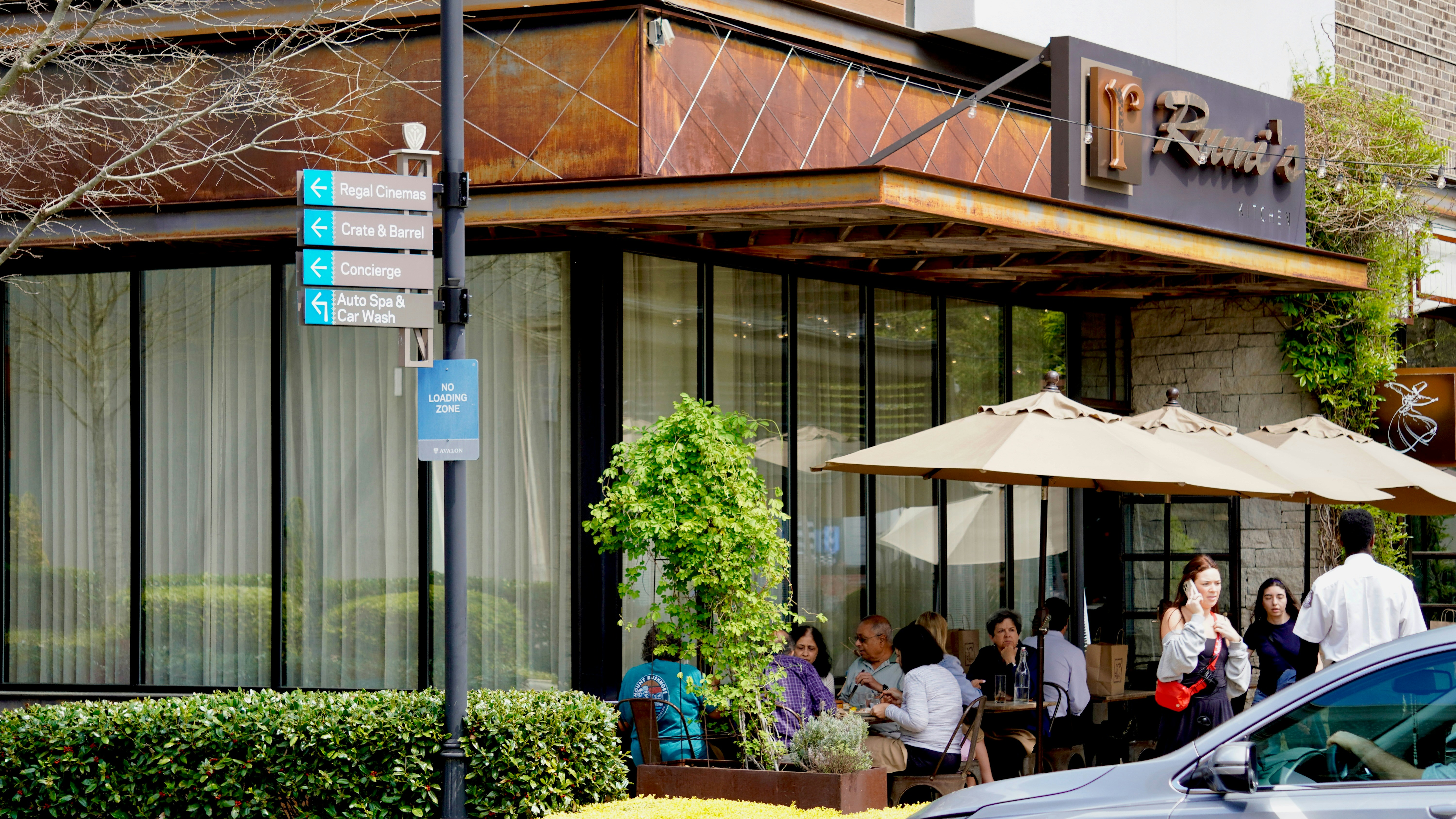 Cafe Corner: People Gather Under Awned Shade Beside a Glass-Front Storefront