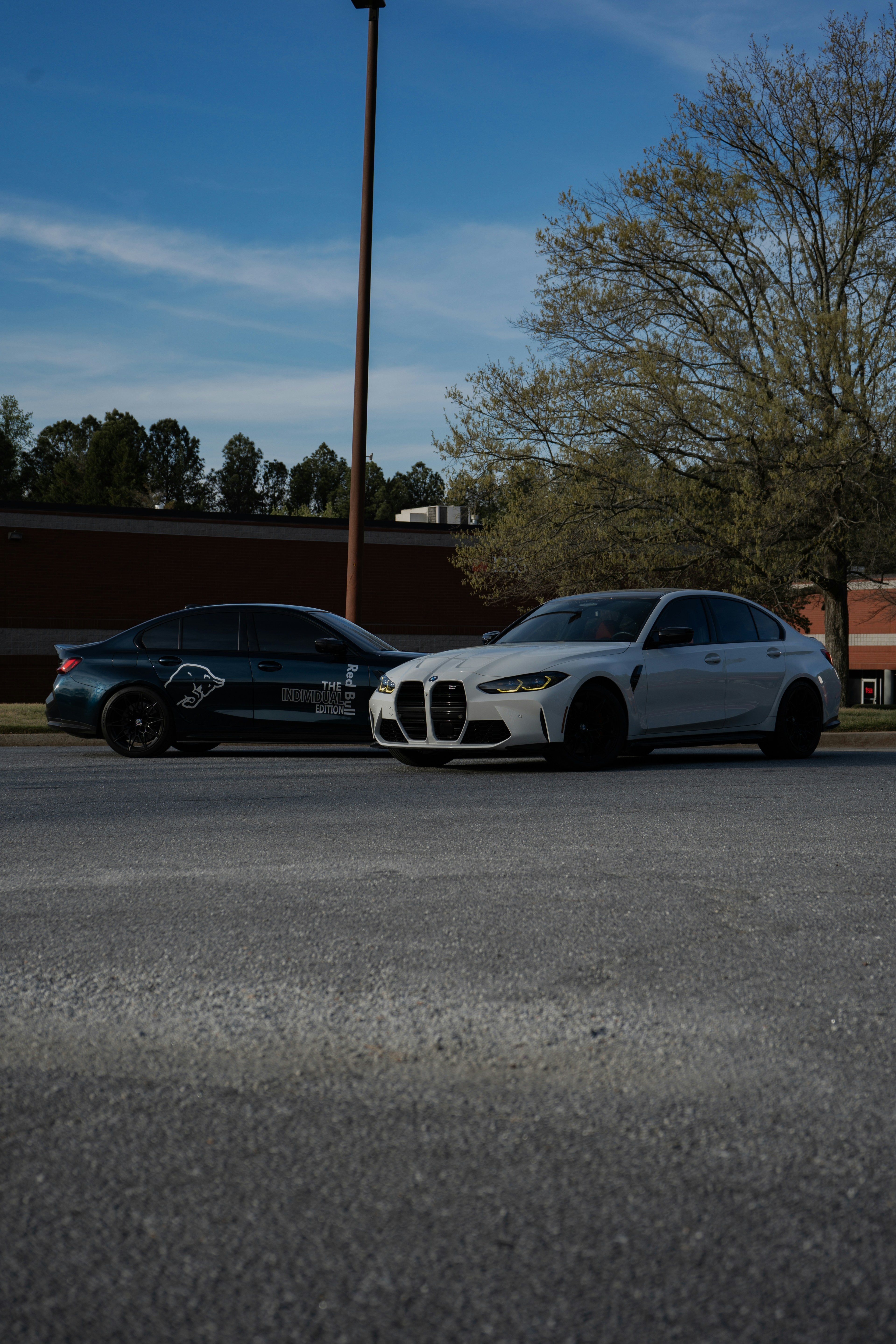 Two Coups in the Lot: White M3 Flares beside a Darker Coop