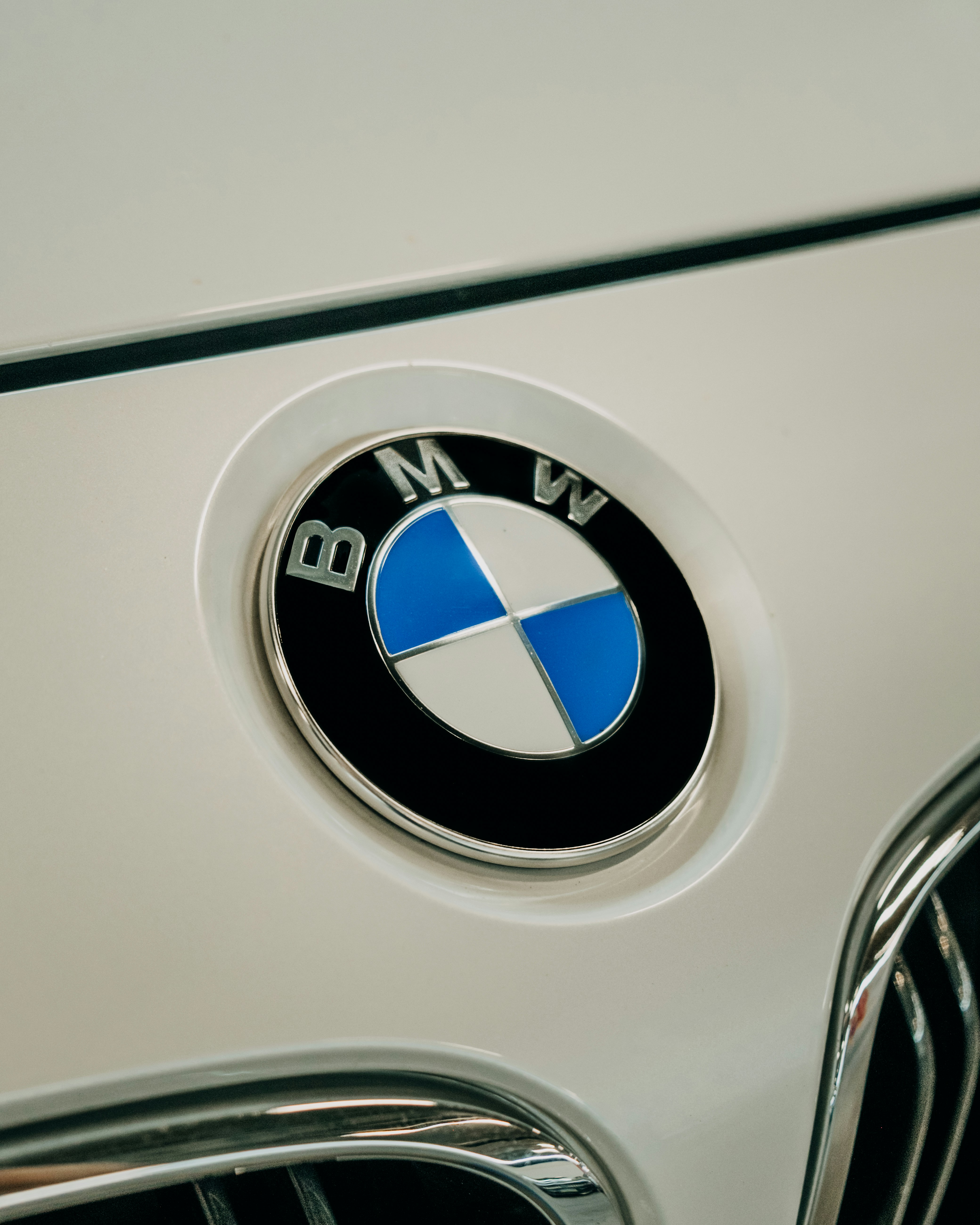 BMW emblem in soft-focus classic car paint