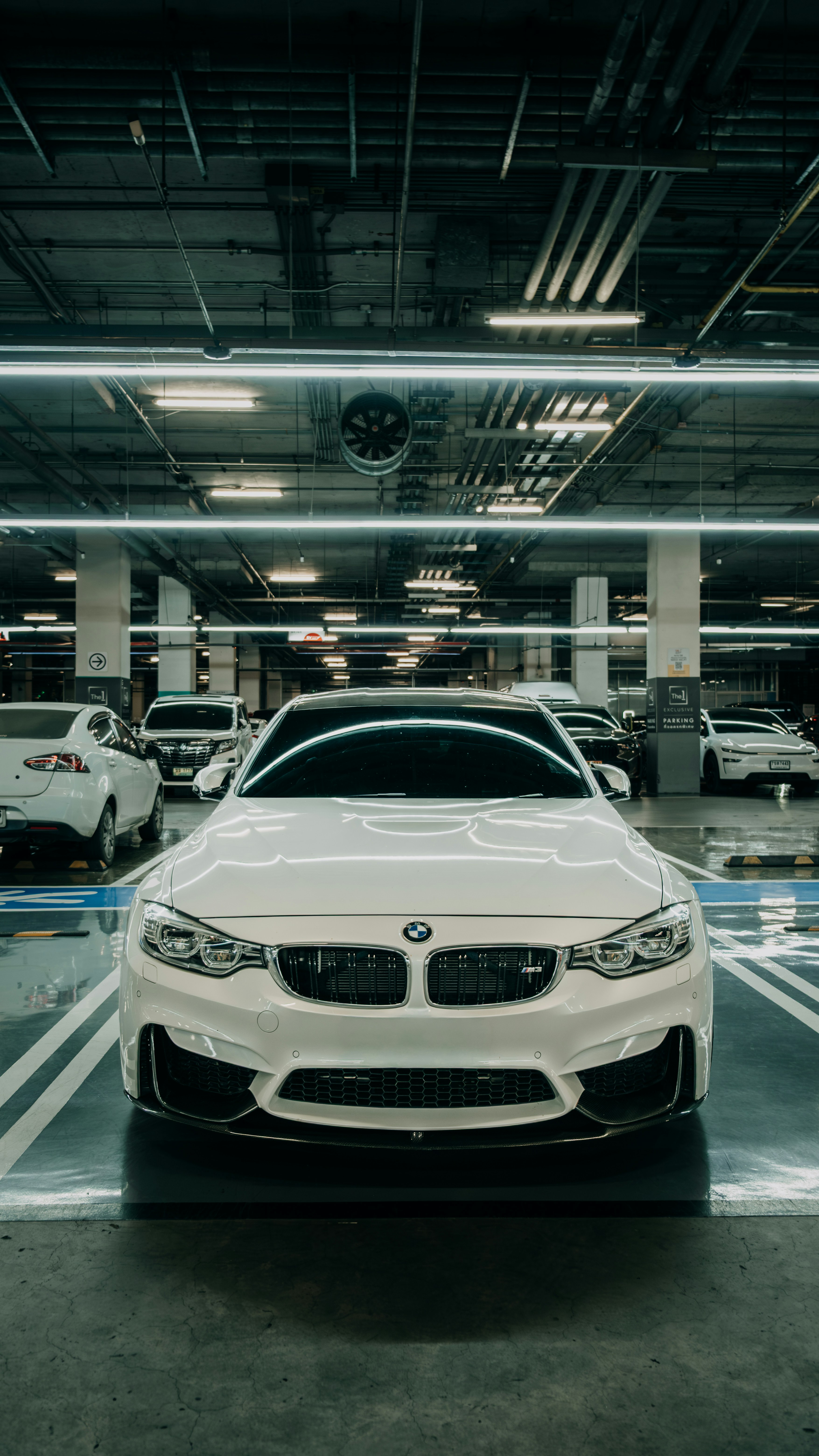 Centered Precision: White BMW Anchors the Parking Garage