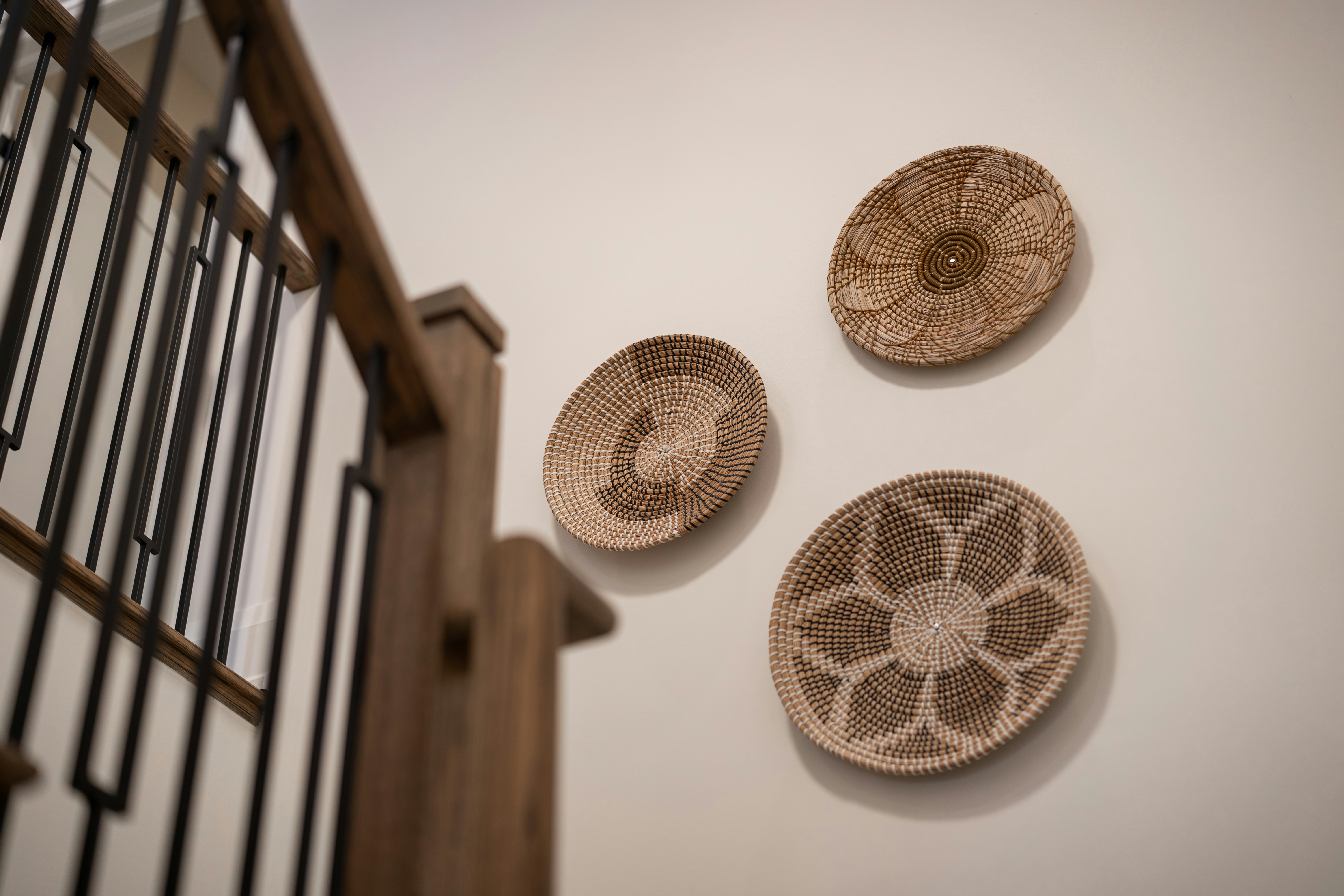 Woven Wall Orbs Above a Subtle Staircase
