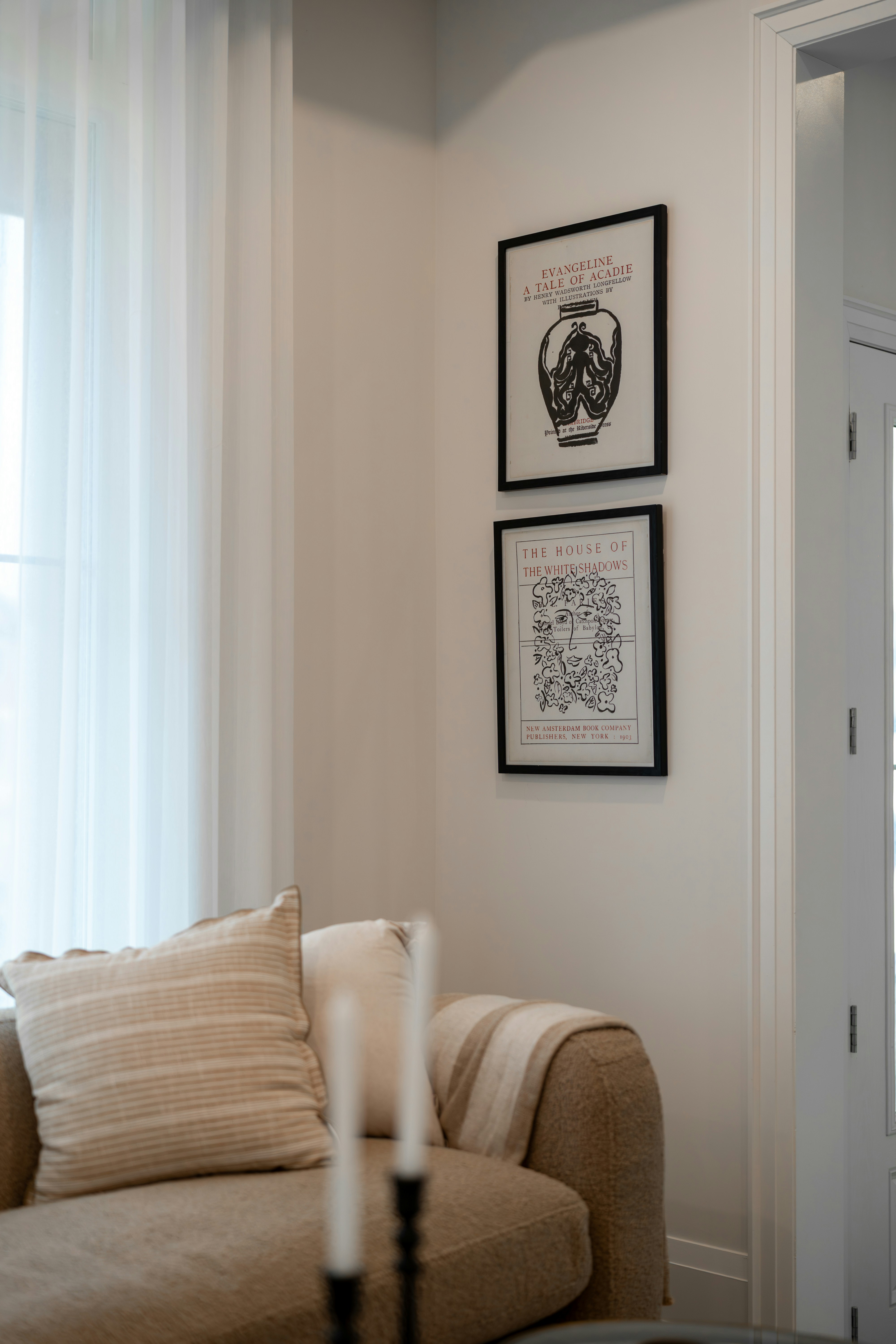 Minimalist Reading Nook: framed prints above a cozy sofa