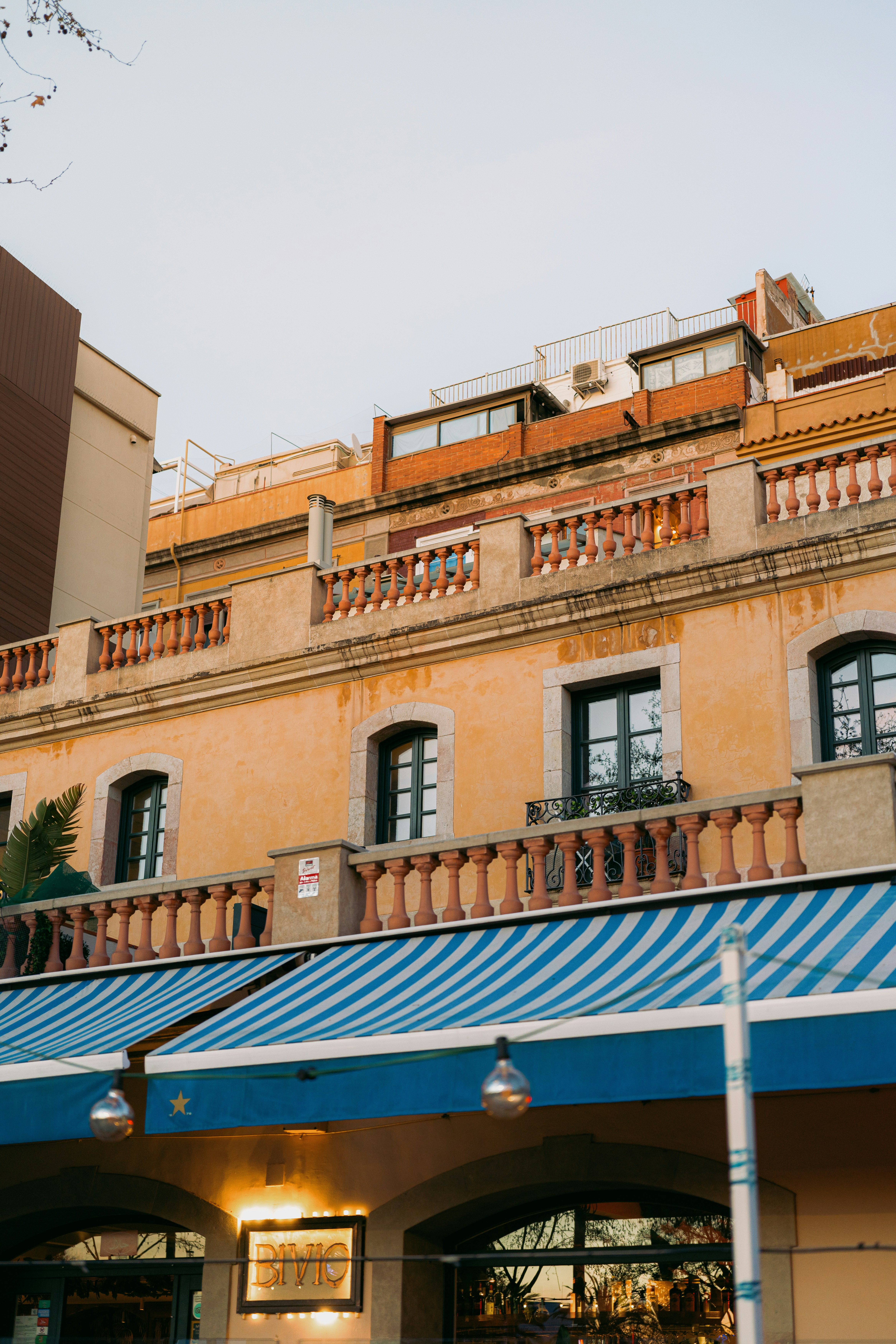 Sunlit Facade and Striped Market Canopy