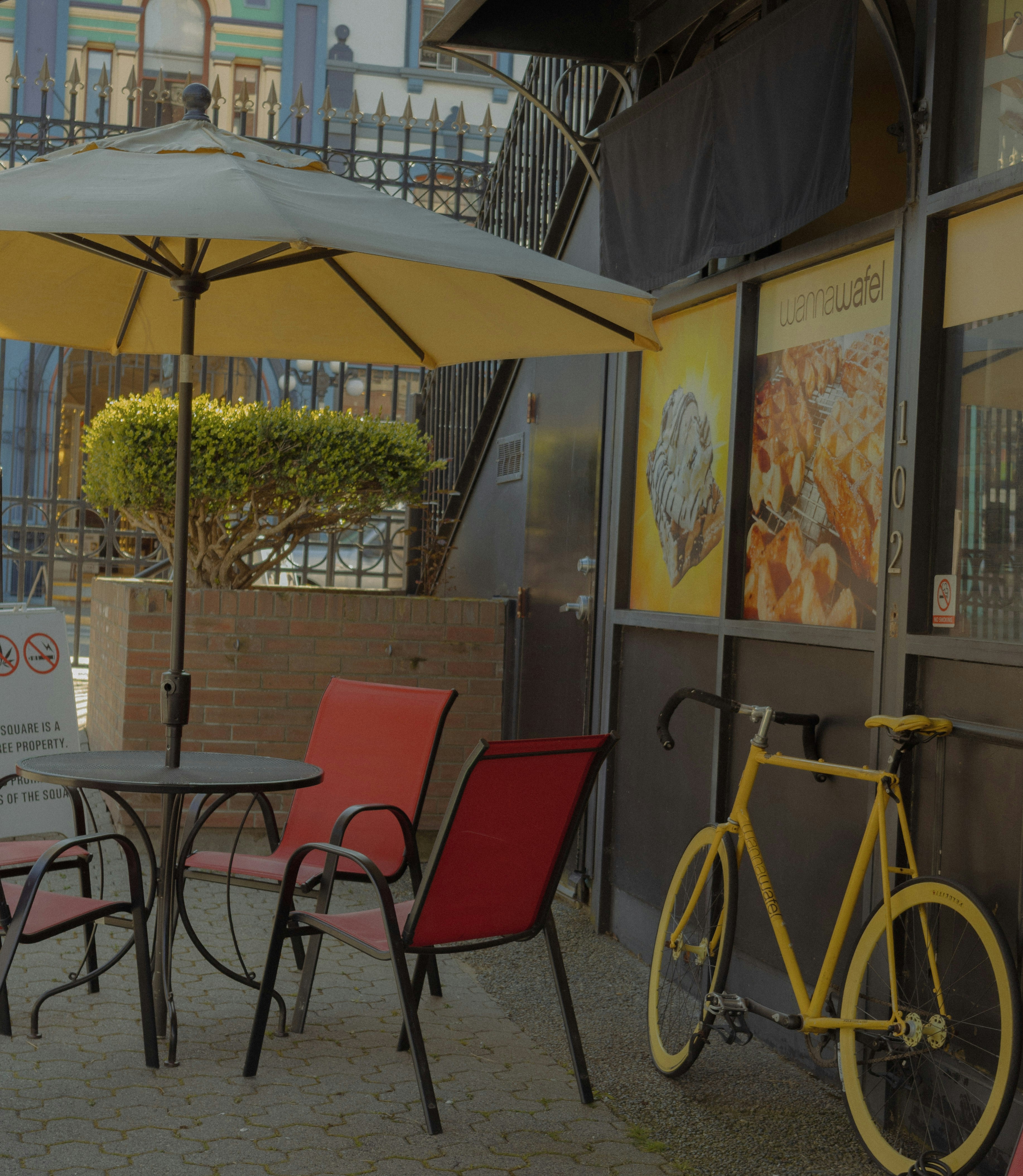 Yellow Bike and Café Terrace under Soft Urban Light
