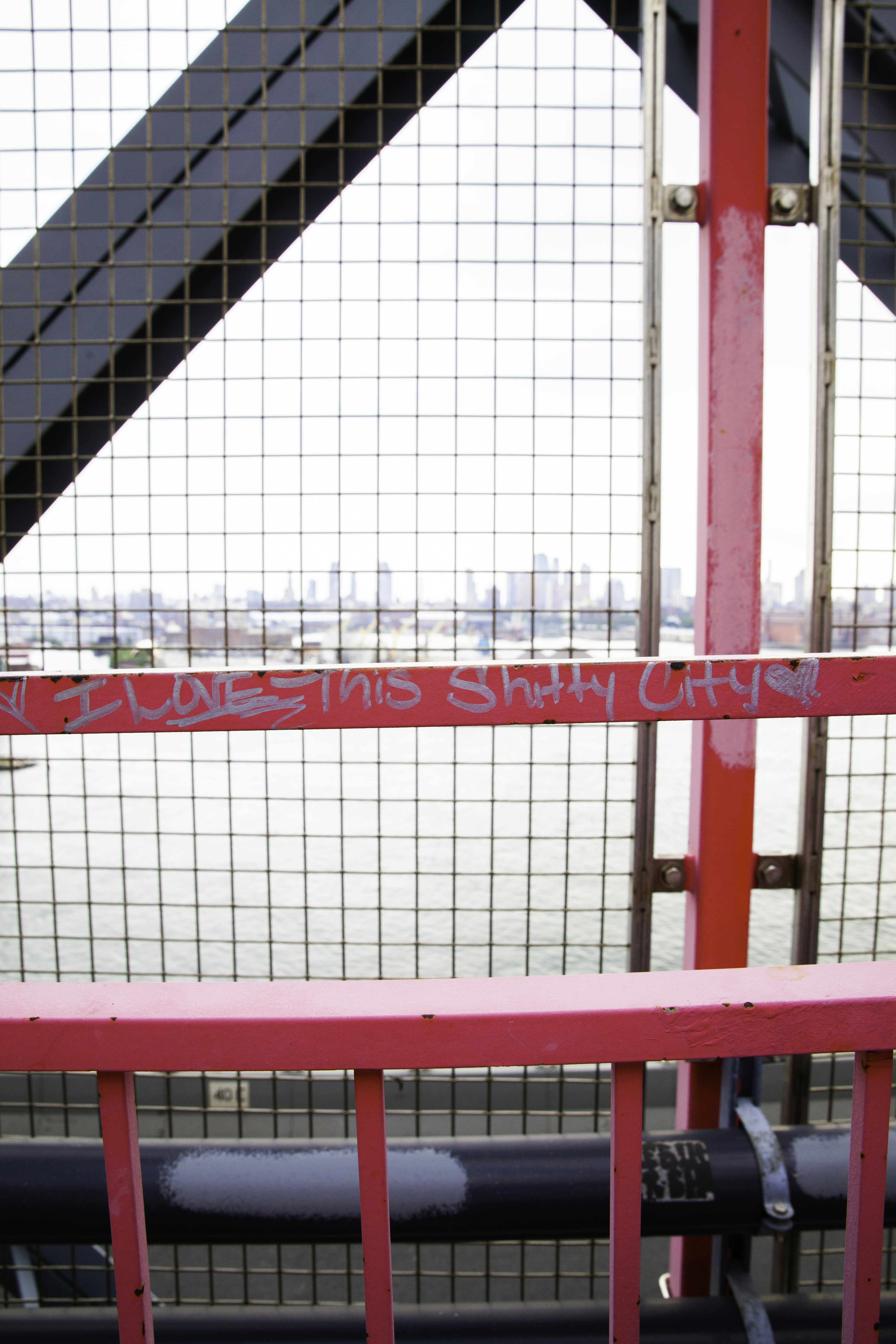 Pink Railing Fragments: Graffiti, Grid, and a Distant Skyline
