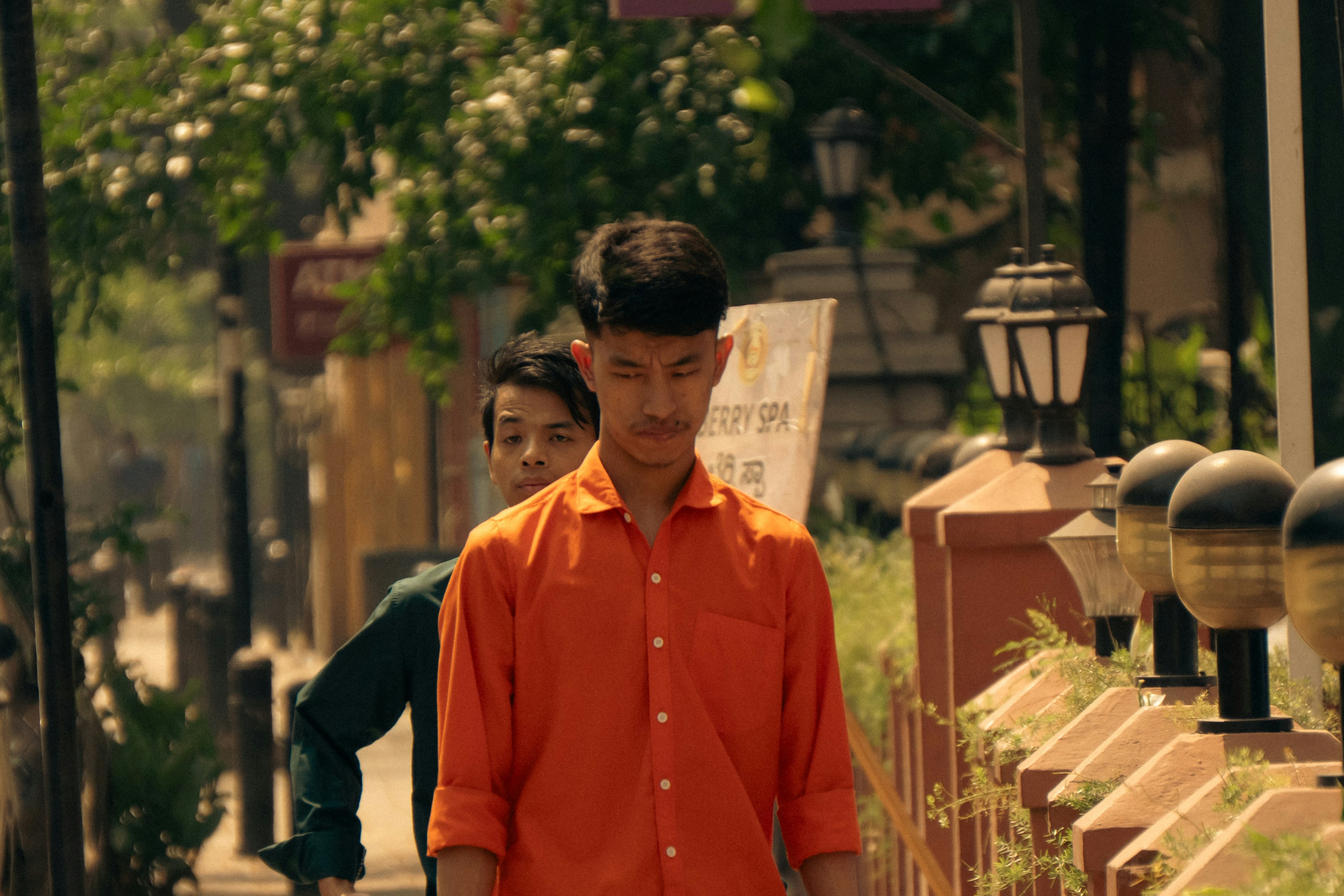 Orange Shirt, Quiet Tension: A Portrait of Departure in the Street