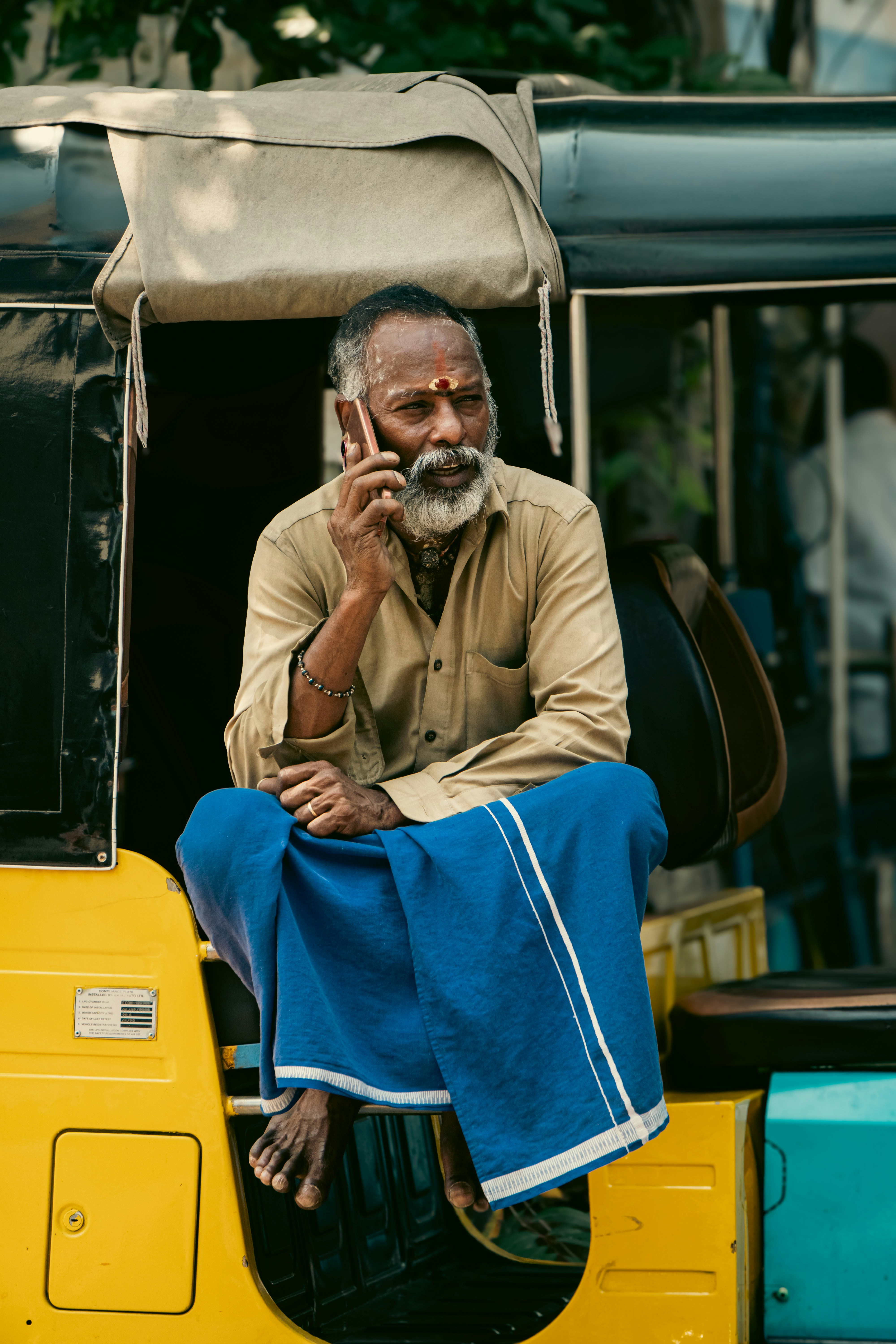 On a Sunlit Step: A Telephonic Moment on a Tuk-Tuk