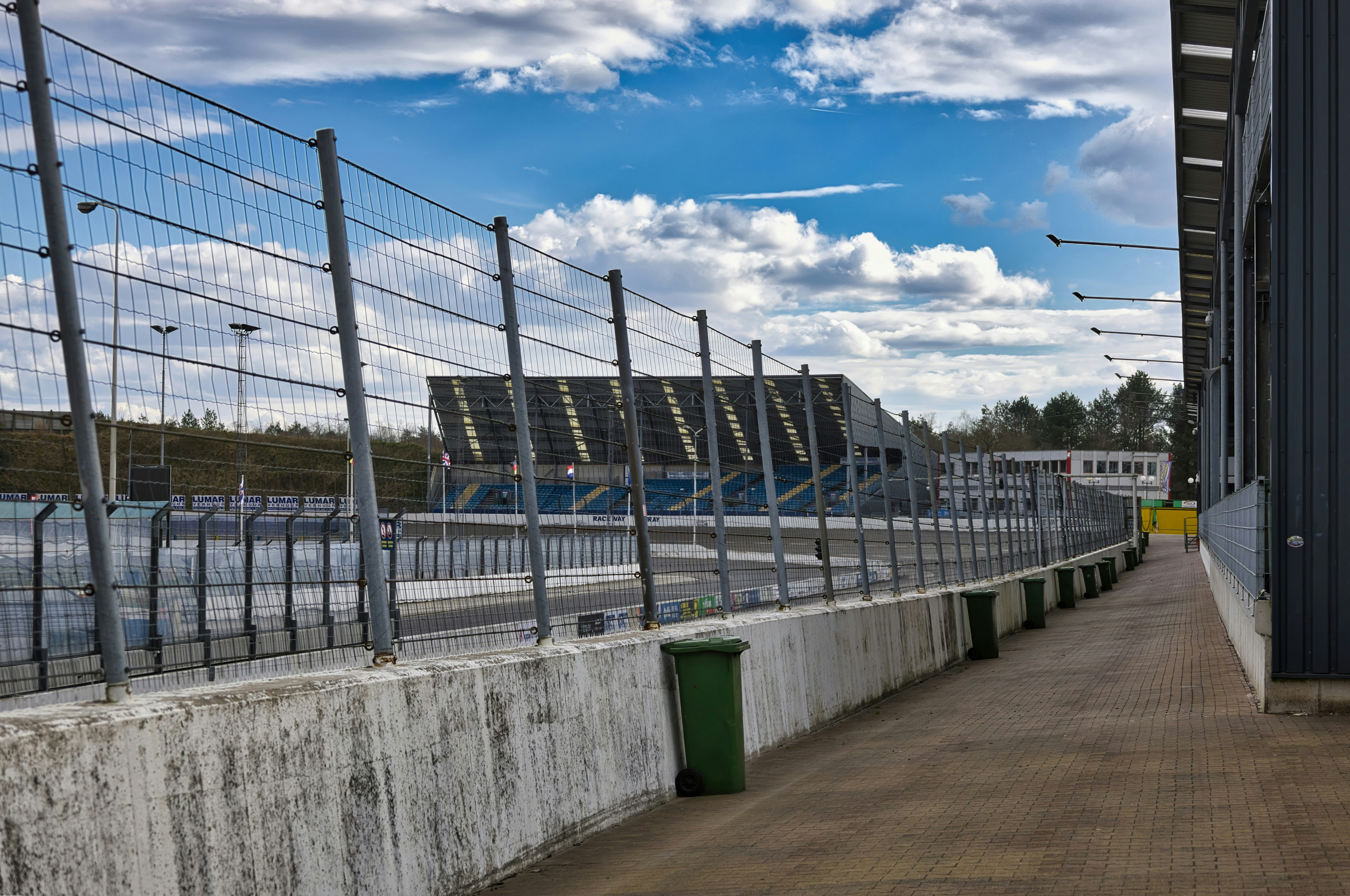 Racing Pit Corridor Under a Sky of Contrasting Clouds