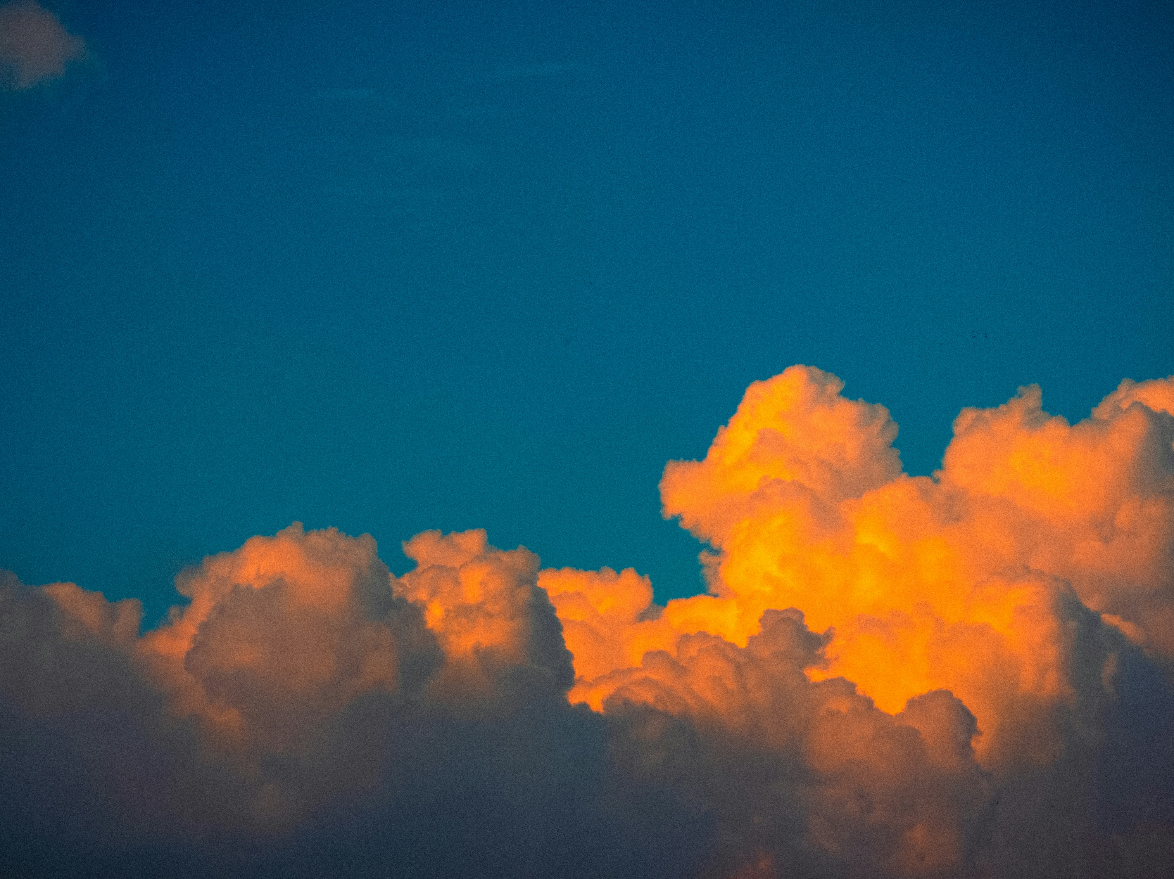 Flame-lit Cumulus Over Calm Blue
