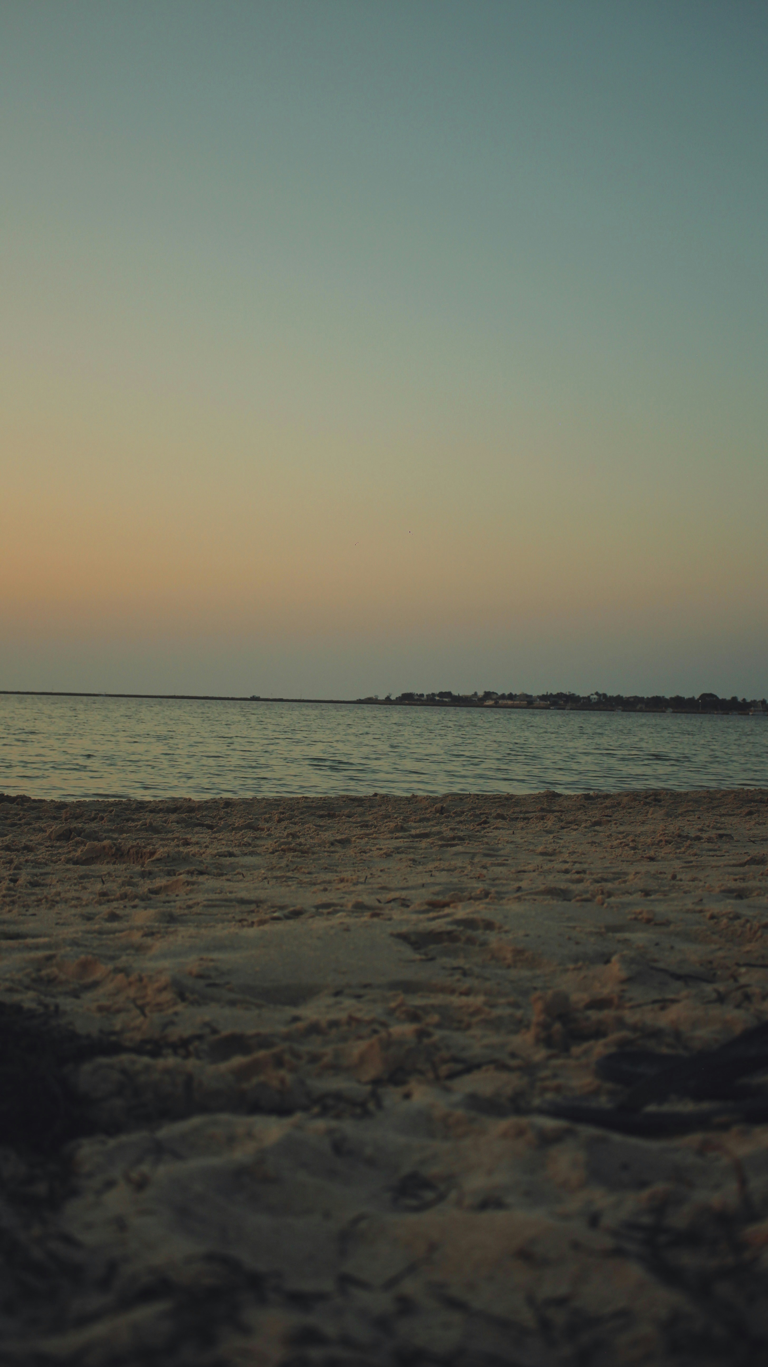 Dusk on the Quiet Shore: Sand, Sea, and Gentle Horizon