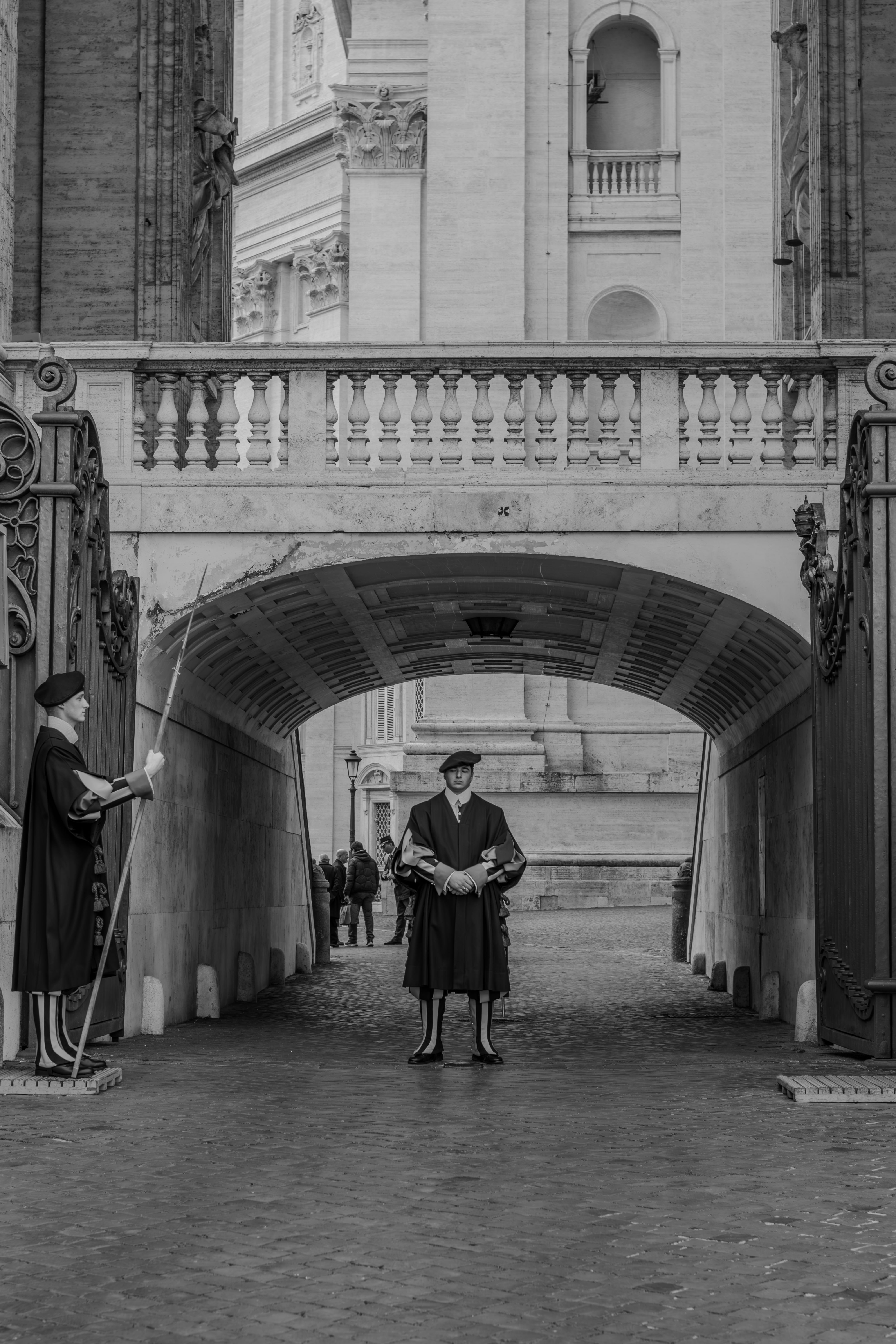 Guarded Archway: A Humble Standoff Under Stone Arches