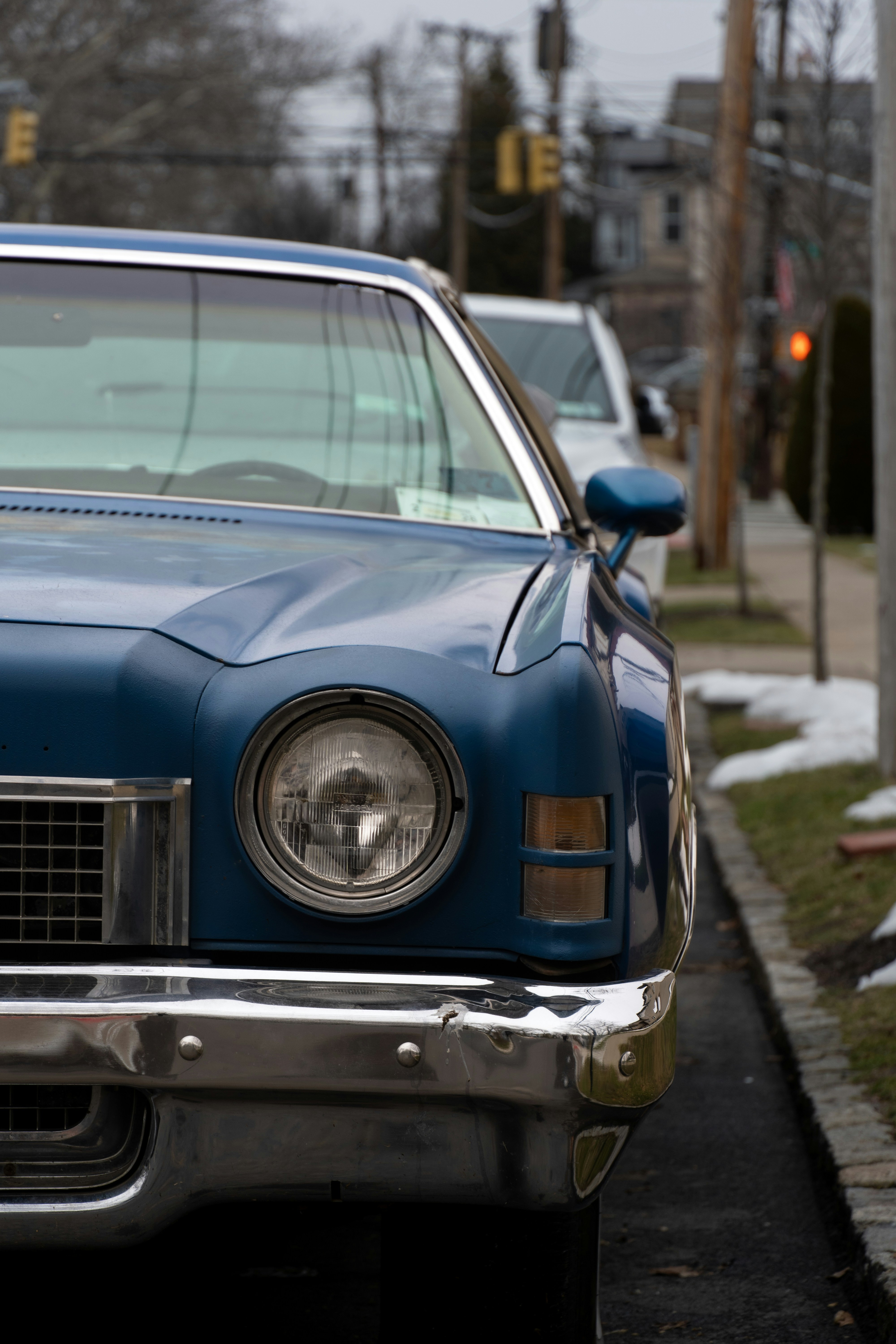 Blue Classic: Front-Quarter Glare on a Roadside Vintage