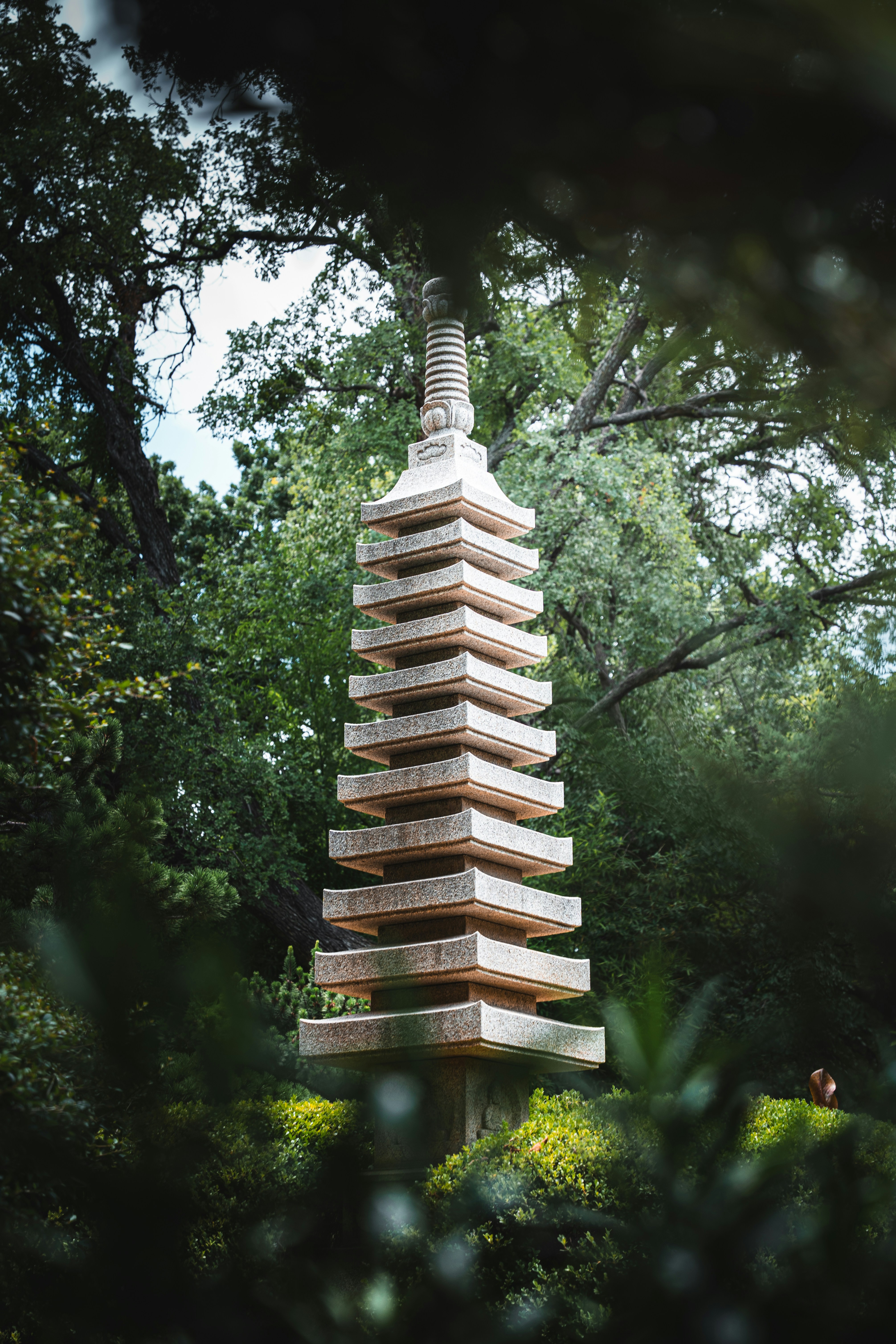 Stone Pagoda Rising Through Green Canopy