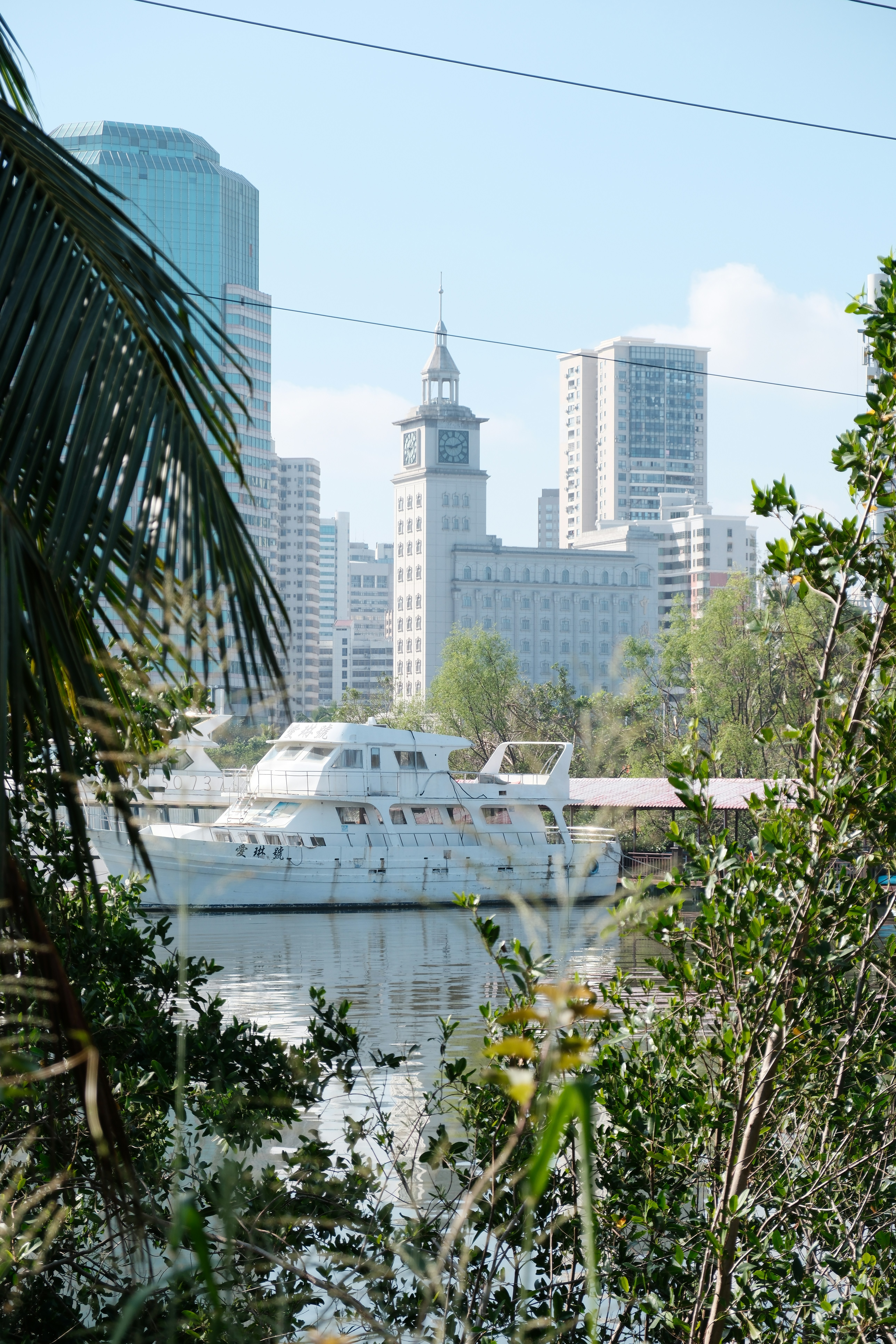 Harbor Clocktower: City Silhouette and Boat in Blooming Waterfront