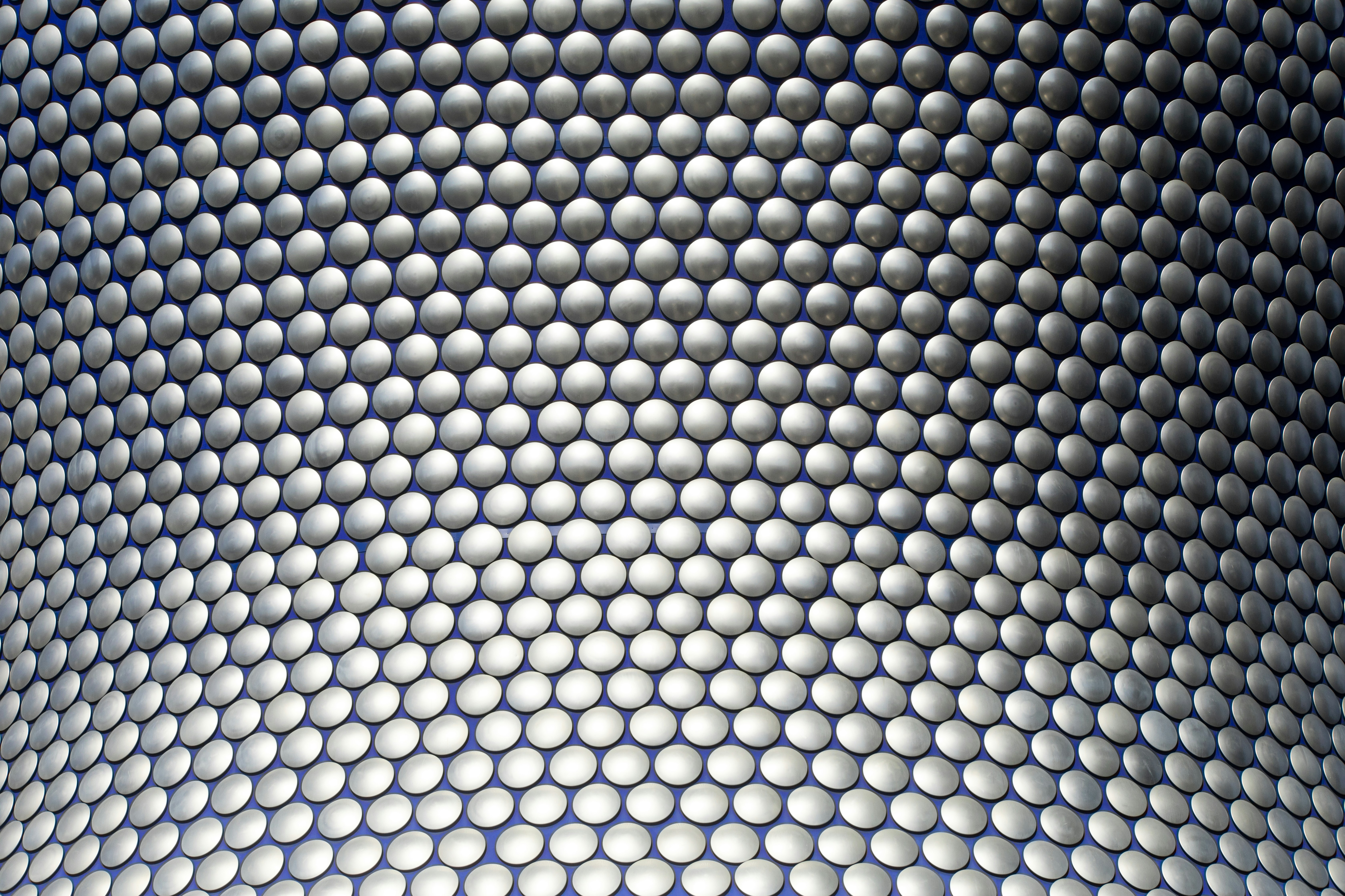 Rings of Light: A Tiled Metallic Surface Recurring in Gentle Curves