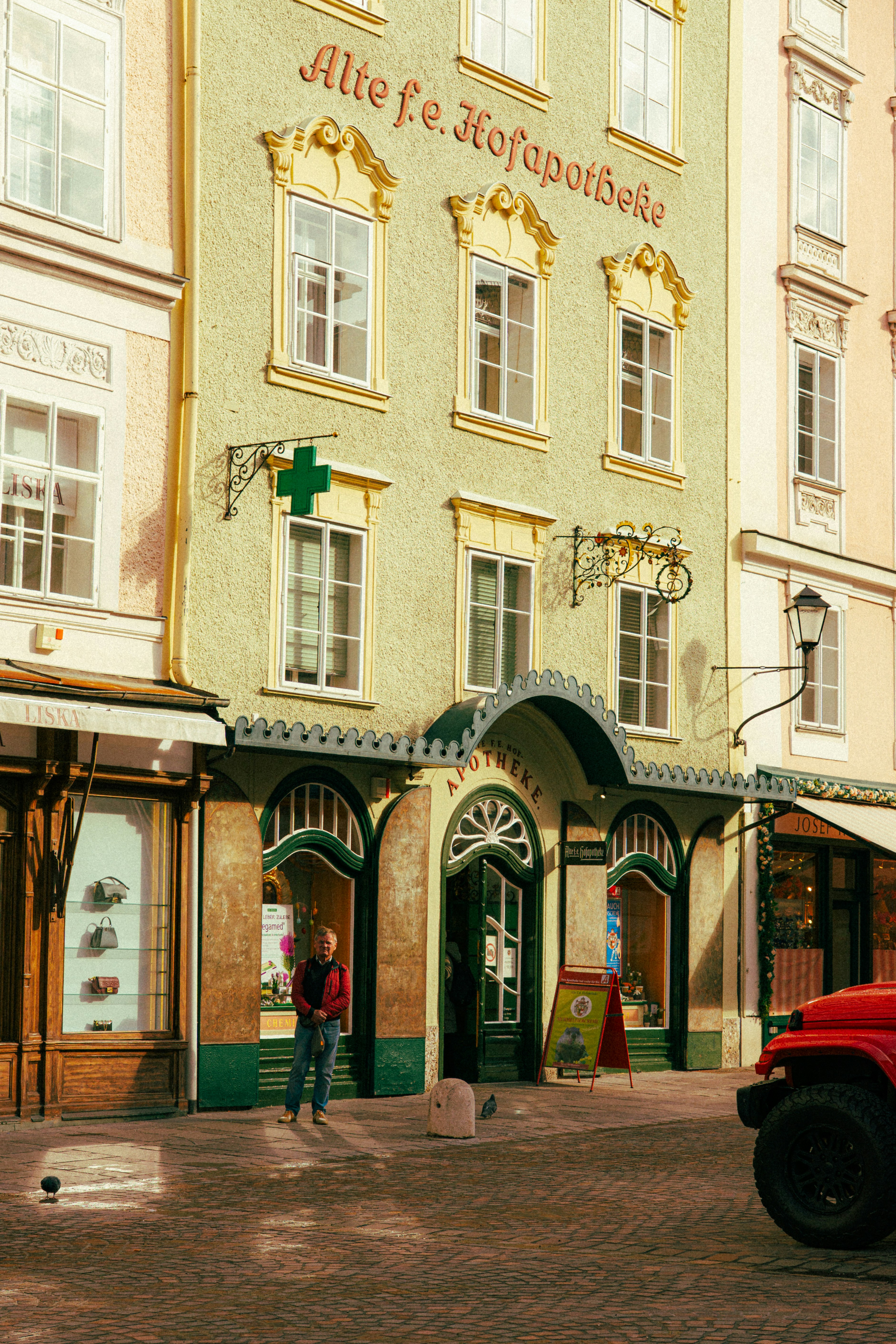Old Town Pharmacy Facade: A Quiet Street Scene with a Red Truck Edge