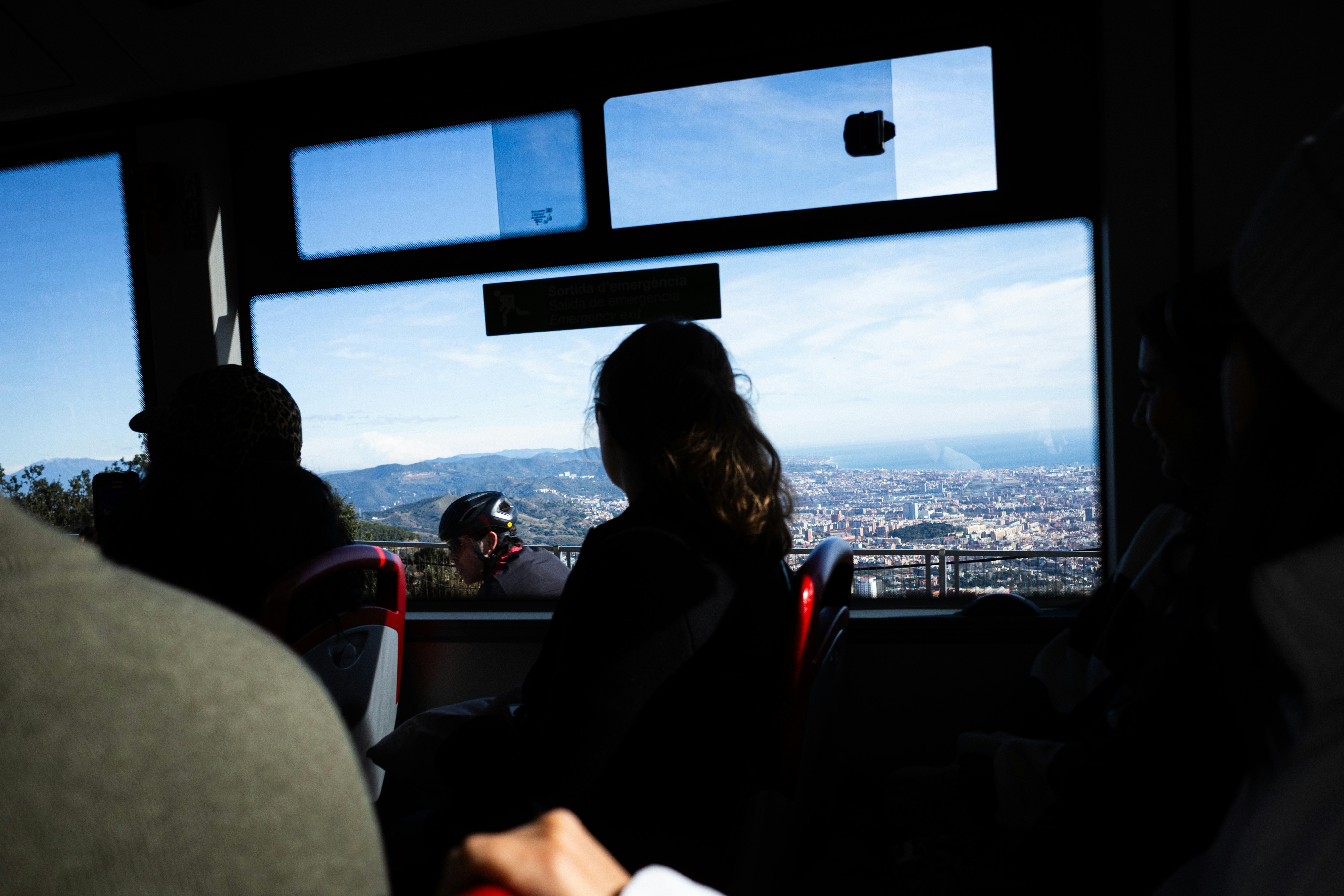 Bus Window Overlook: Cityscape Beyond the Silent Bus
